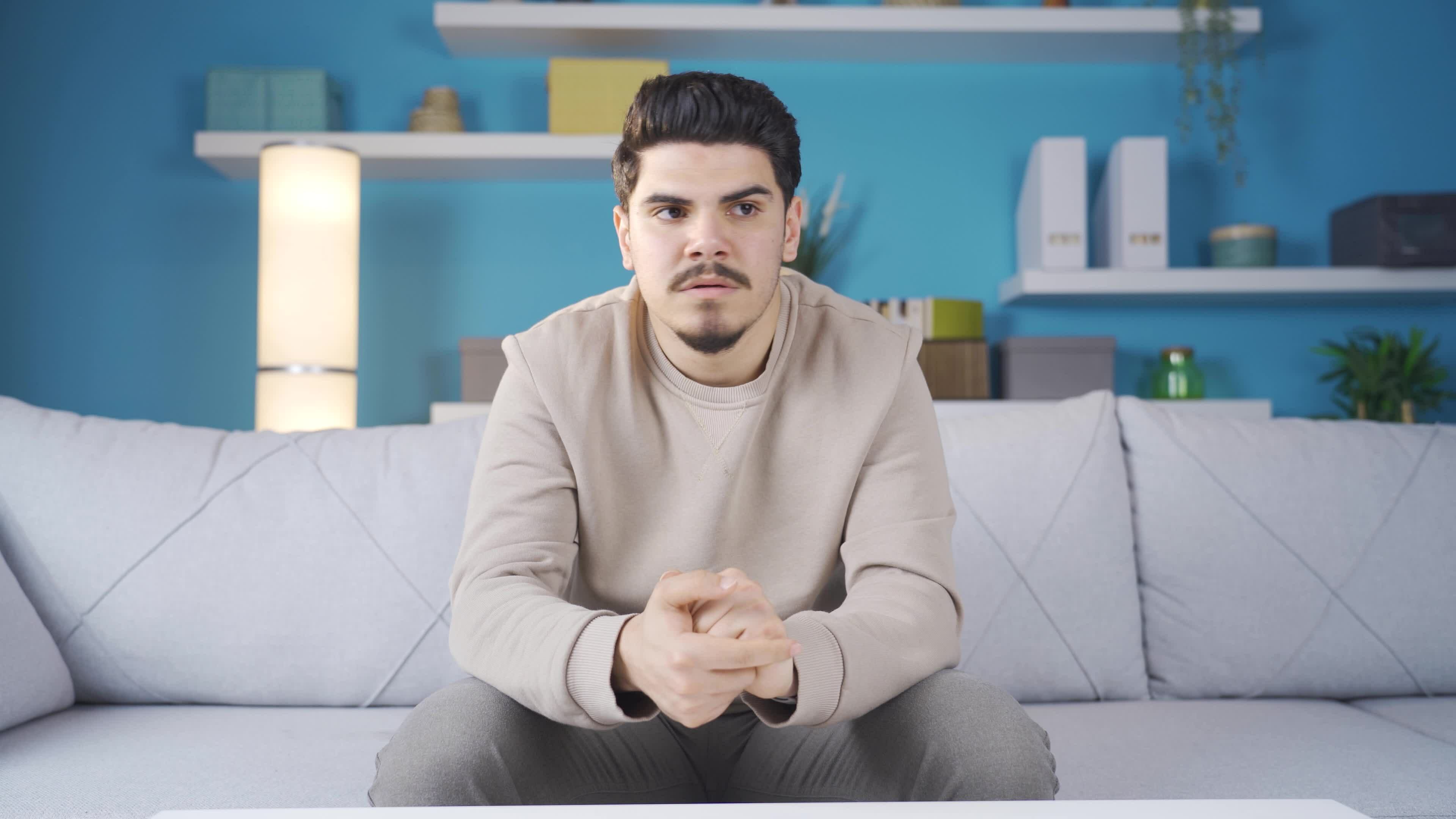 The man looking around worried and uneasy is looking at the camera ...