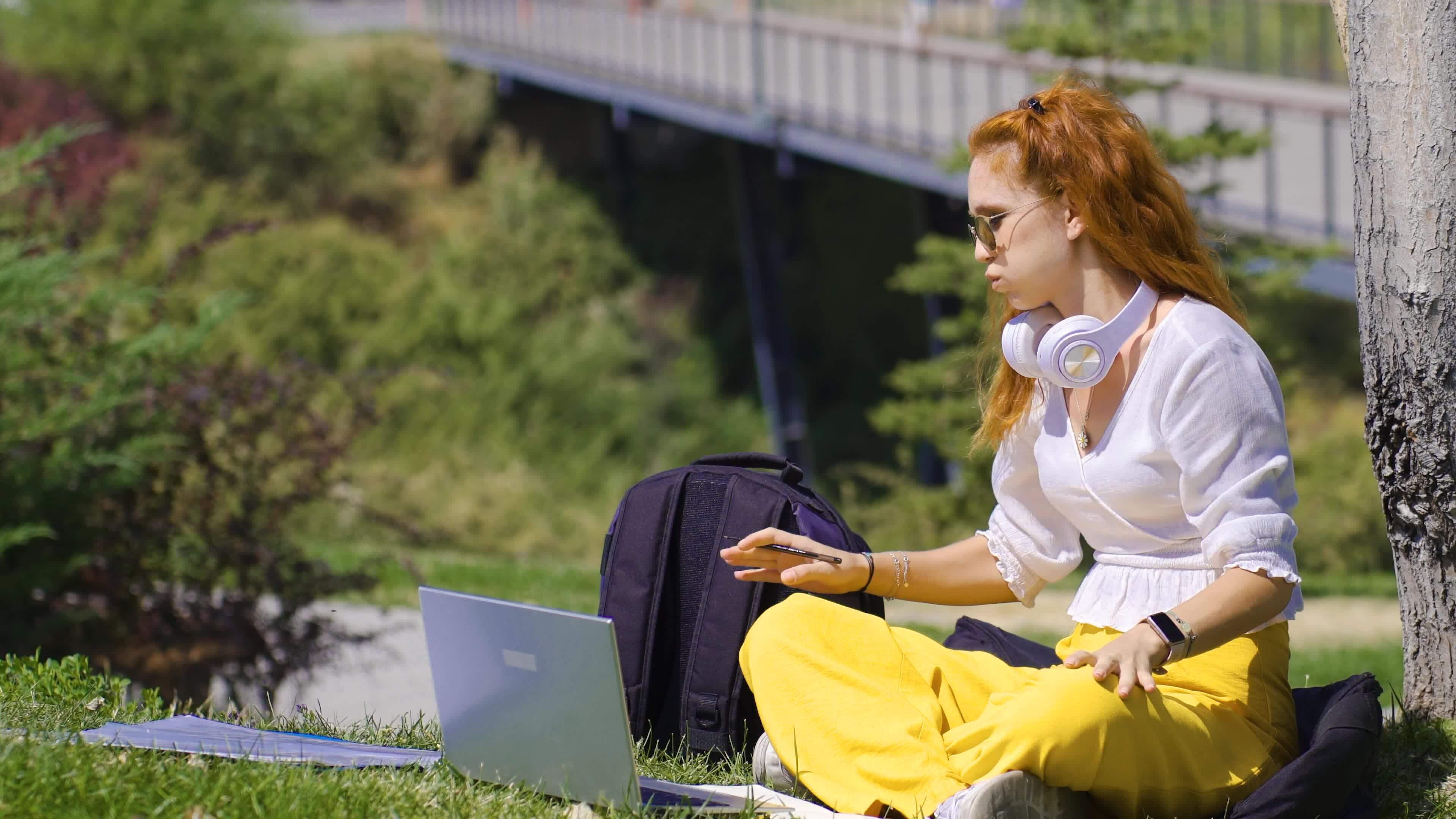 Stressed and nervous college student studying outdoors in park. 33066849 Stock Video at Vecteezy