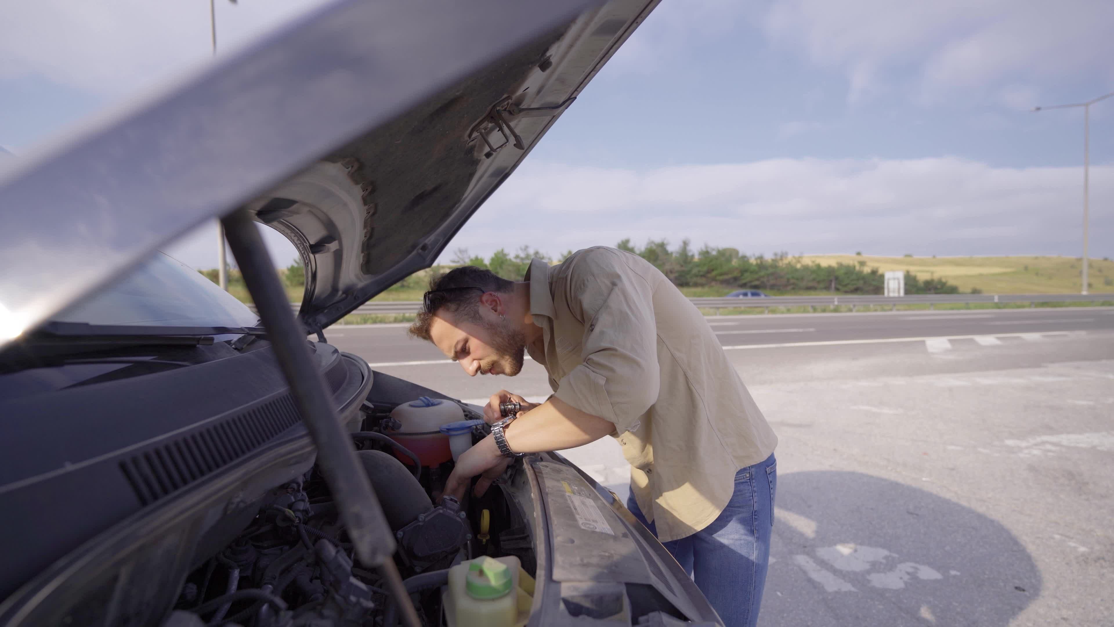 Car breakdown on the highway. Car repair. 33087159 Stock Video at Vecteezy