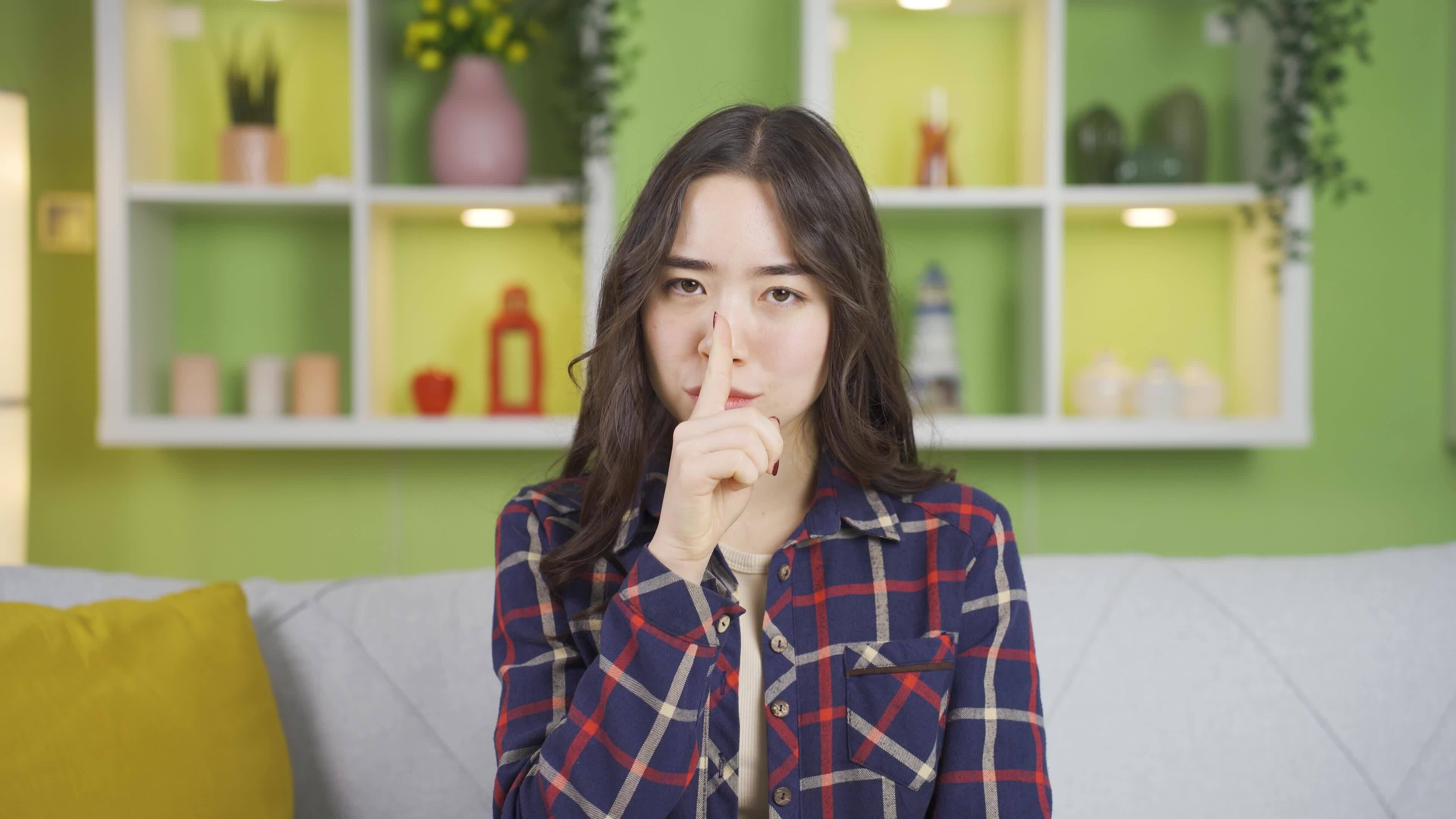 Asian teenager looking serious and sharp at the camera says shut up ...