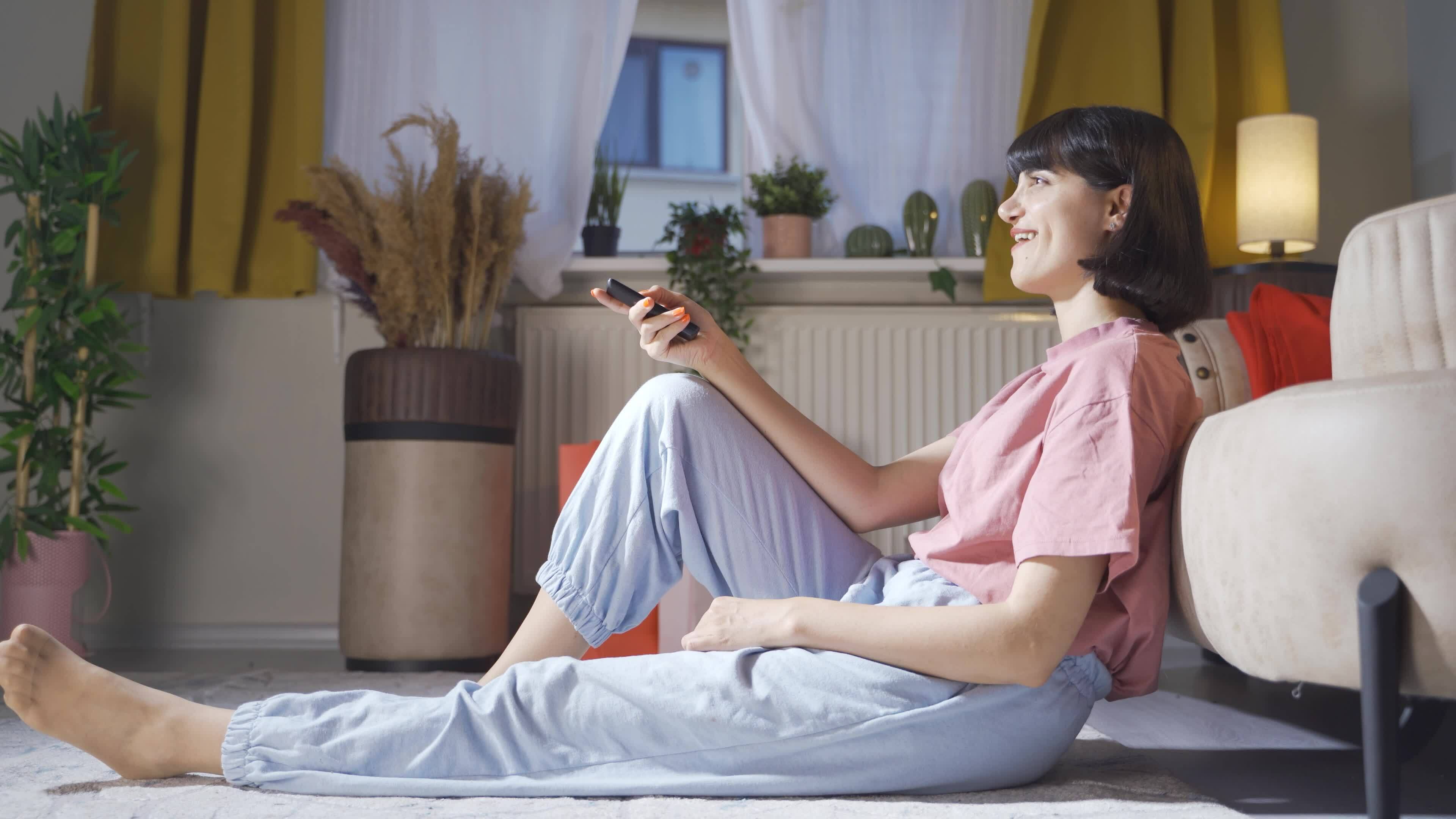 The woman watching TV likes and approves the news. 33171397 Stock Video ...