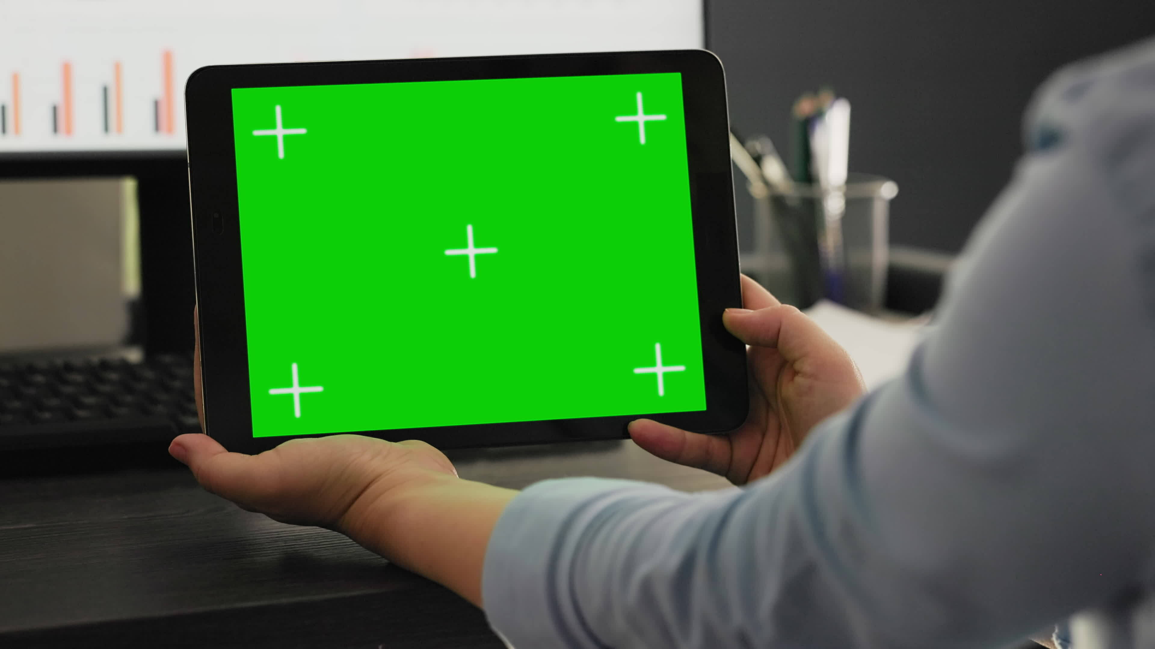 Worker Examines Greenscreen On Tablet In Agency Coworking Space Office Looking At Chromakey