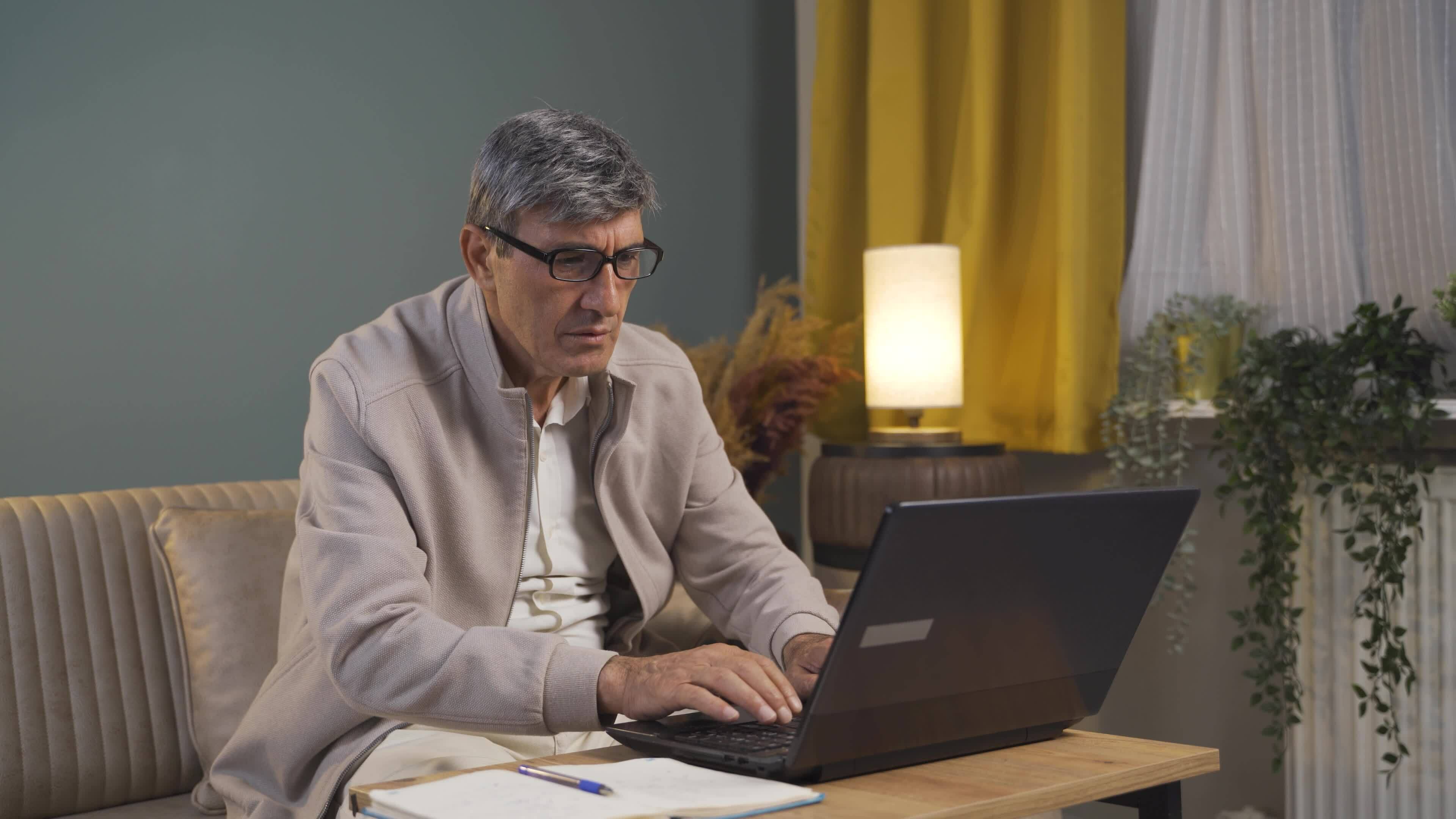 Concentrated old man working on laptop. 33499149 Stock Video at Vecteezy