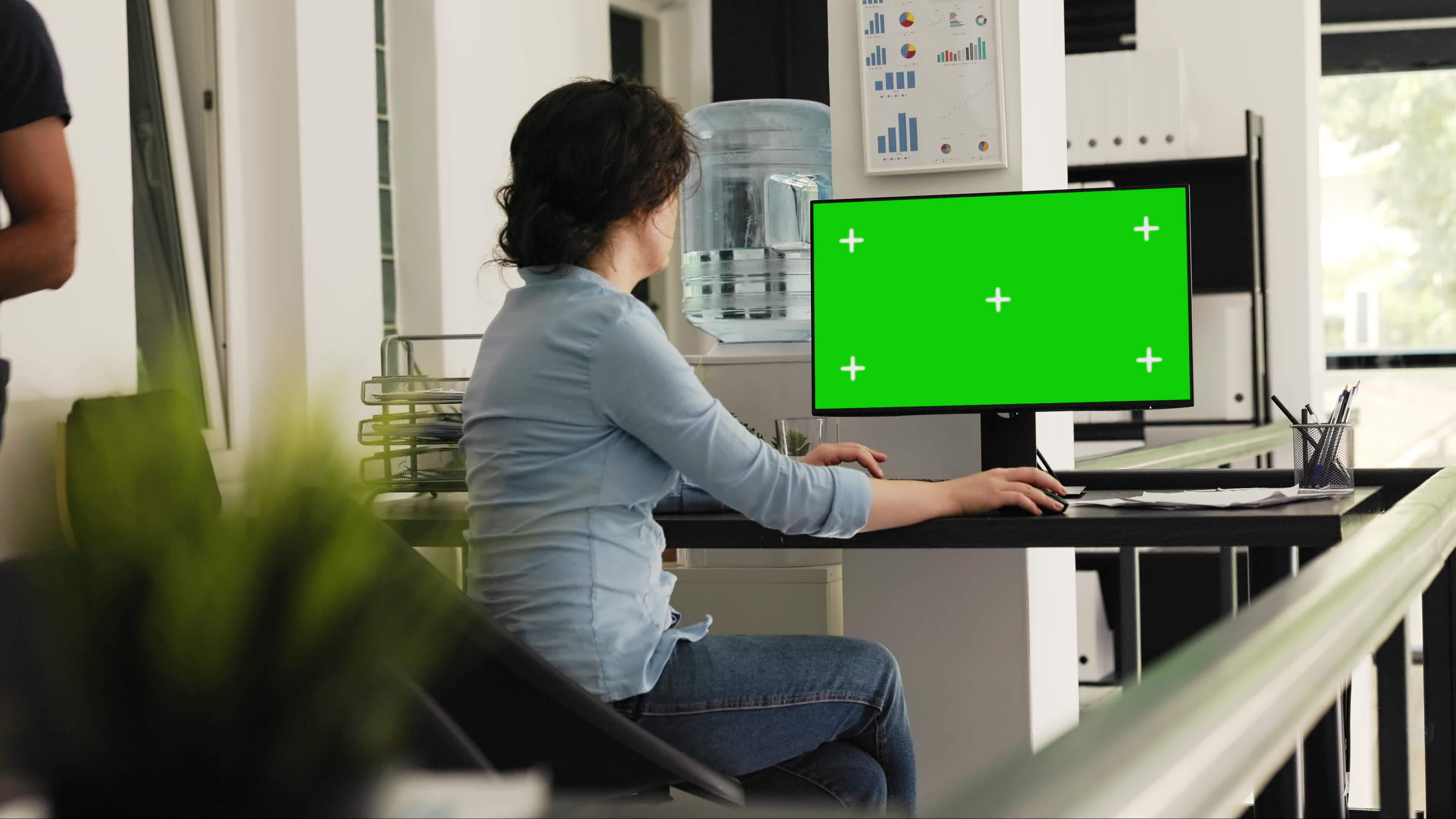 Office Worker Checks Greenscreen Monitor At Desk Working On Business Operations With Blank