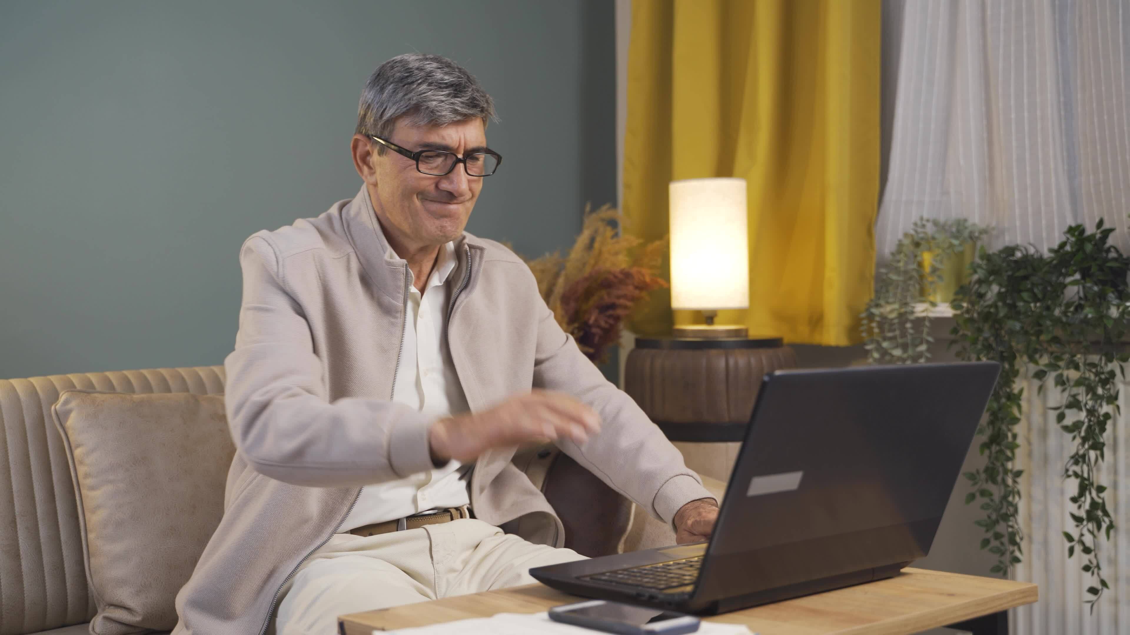 Negative expression of old man using laptop. 33542113 Stock Video at ...