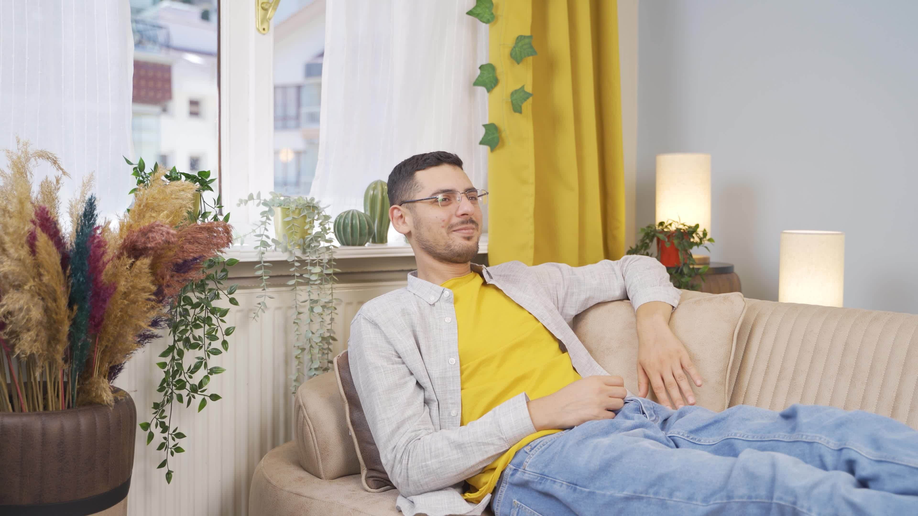 Man lying on the sofa is resting. 33549652 Stock Video at Vecteezy