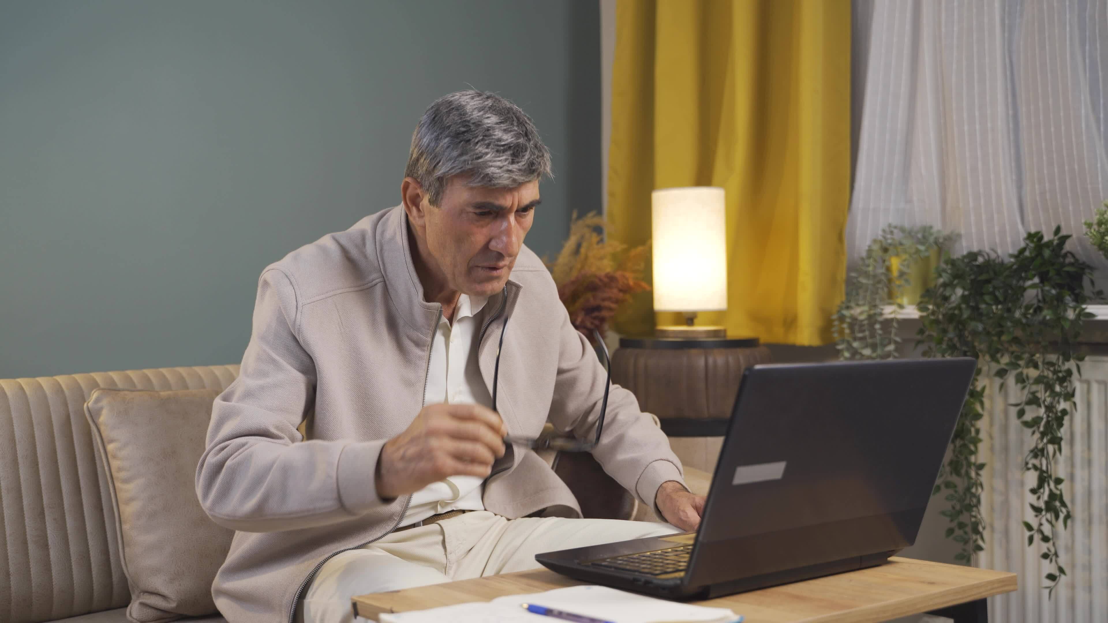 Old man looking at laptop in amazement. 33549874 Stock Video at Vecteezy