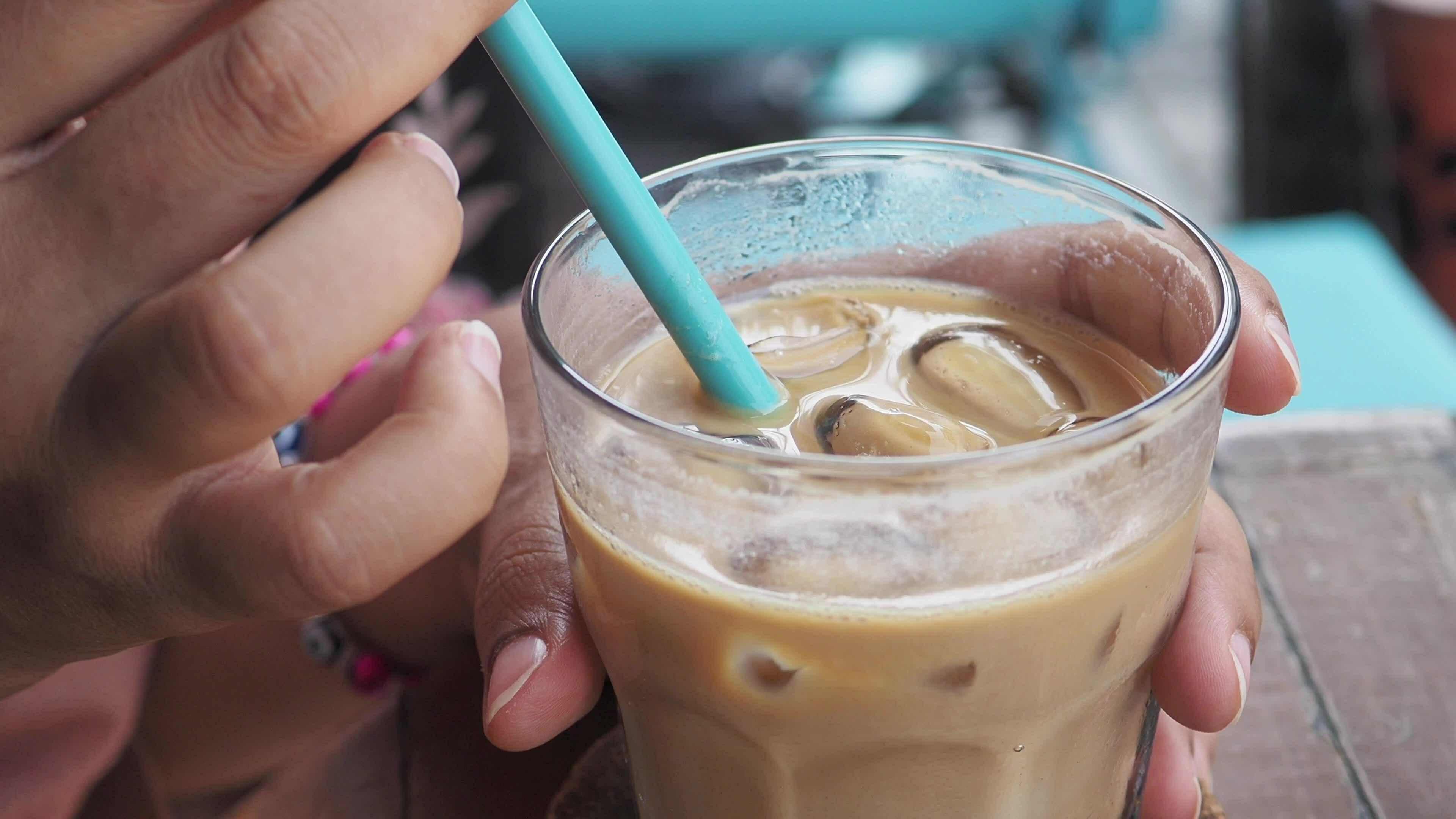 iced late in a transparent glass on cafe table outdoor 33838034 Stock Video at Vecteezy