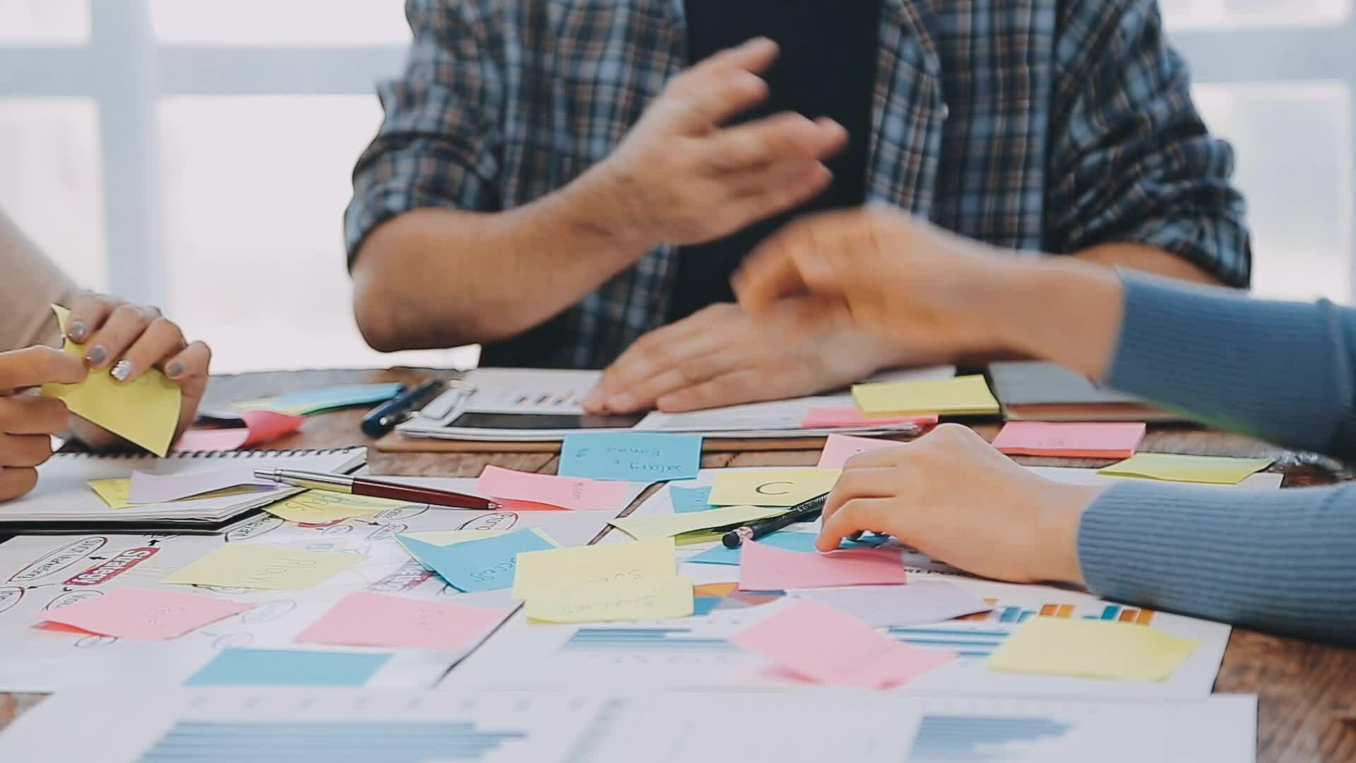 Two creative business people meeting and planning use post it notes ...