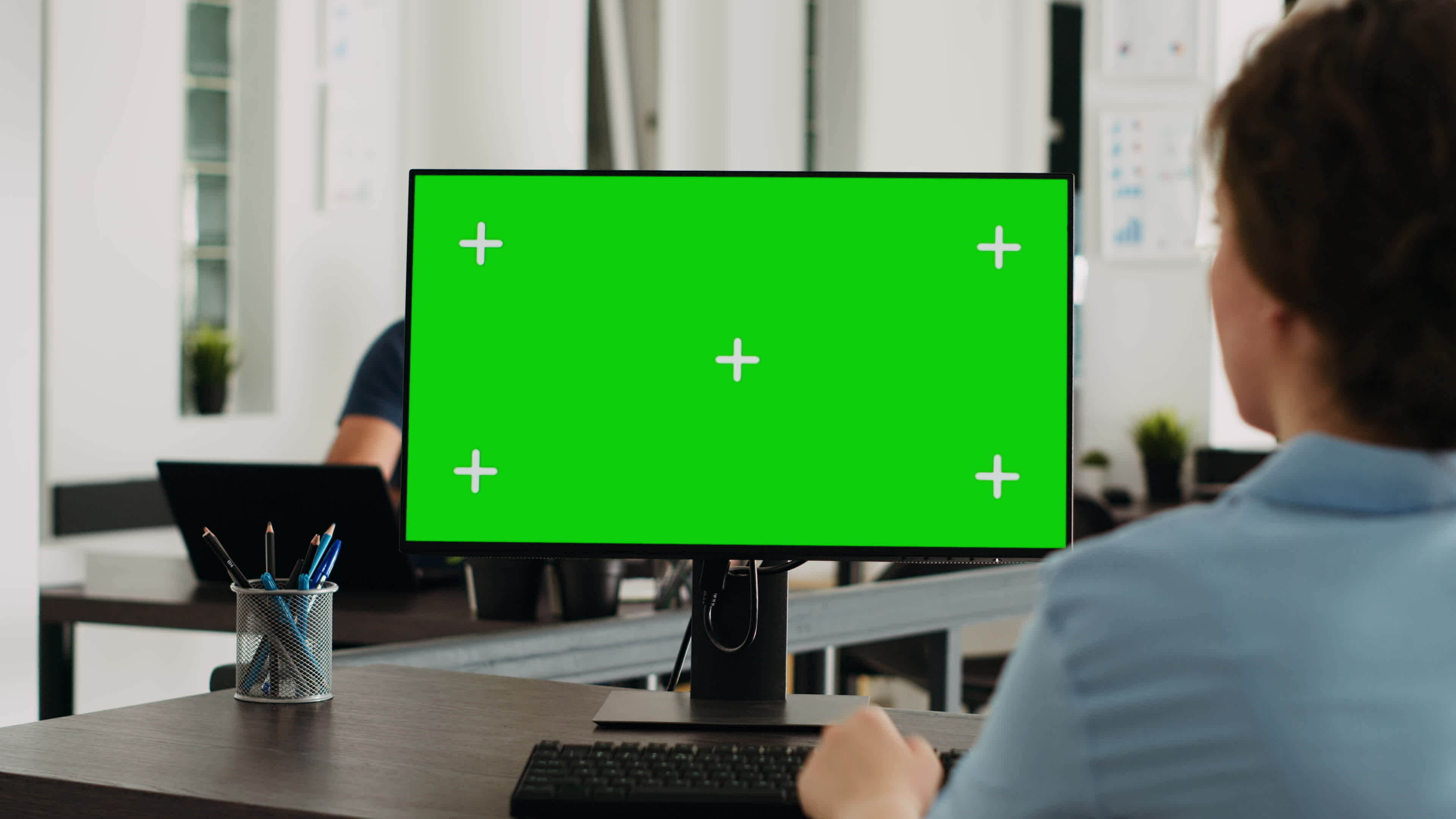 Manager Working With Isolated Greenscreen On Computer At Workstation