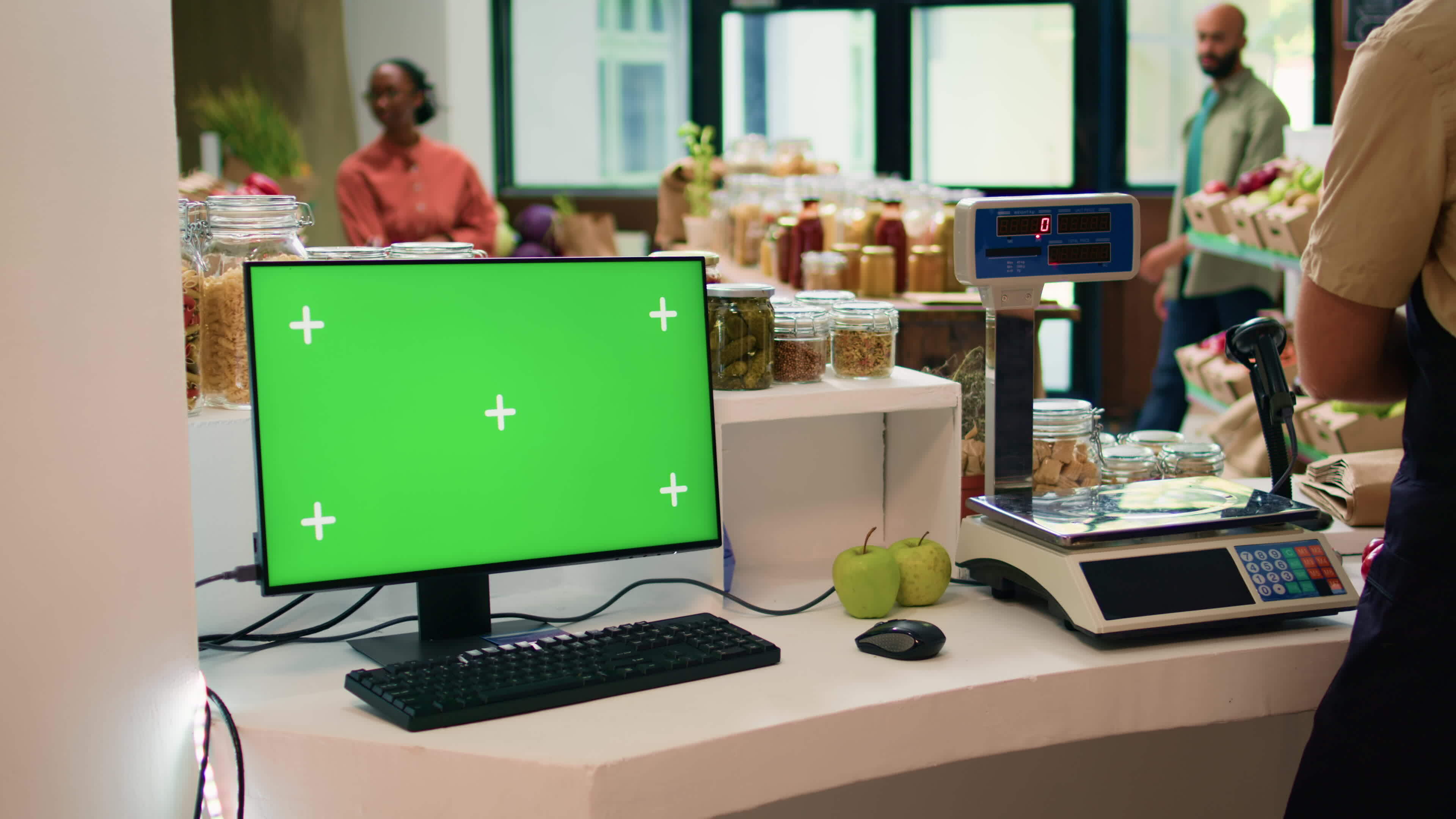 Vendor At Checkout Uses Greenscreen On Computer Showing Isolated Chromakey Display On Desktop