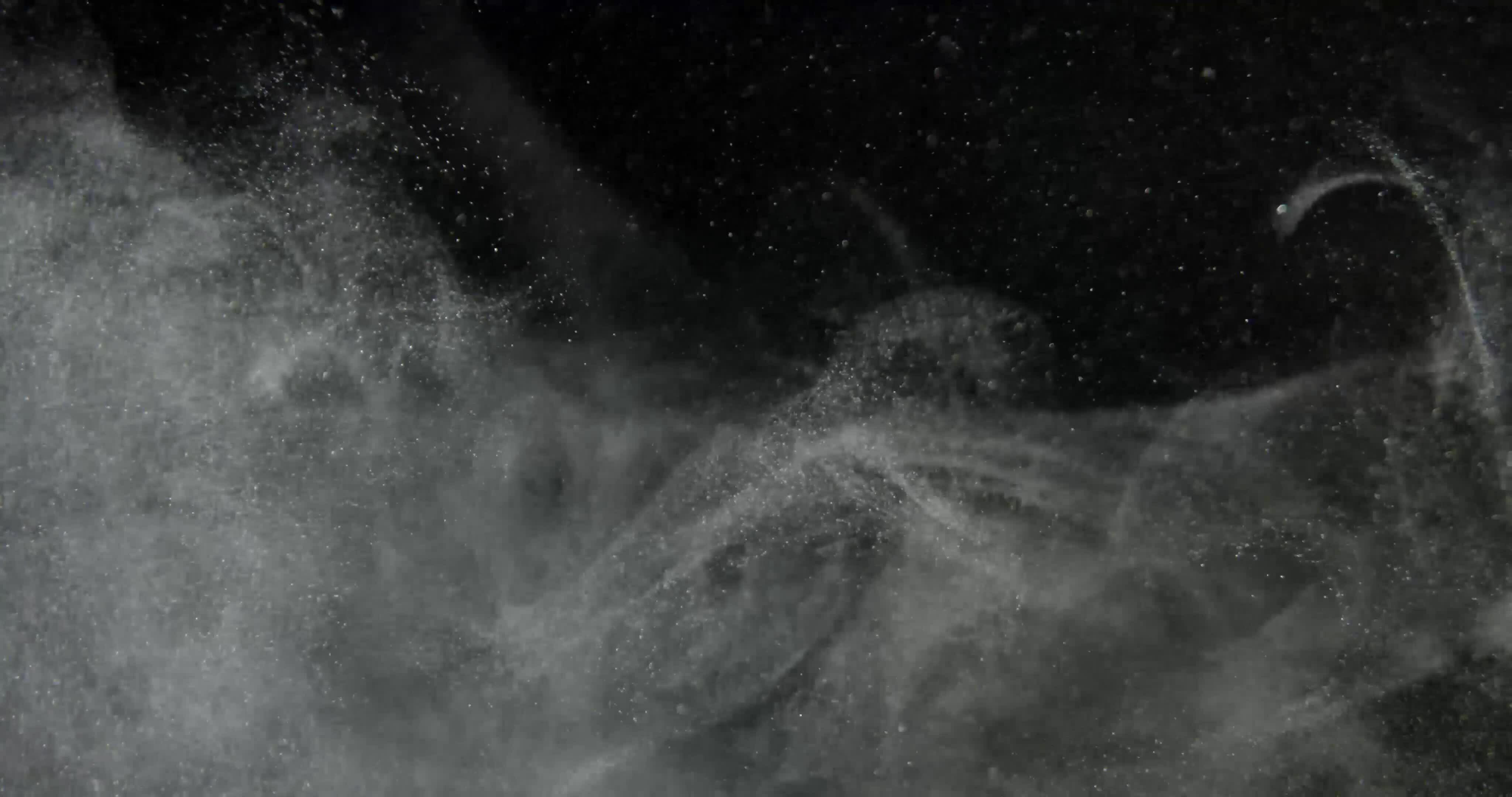 Organic cloud of dust particles floating on black screen overlay. Filmed with RED camera in slow ...