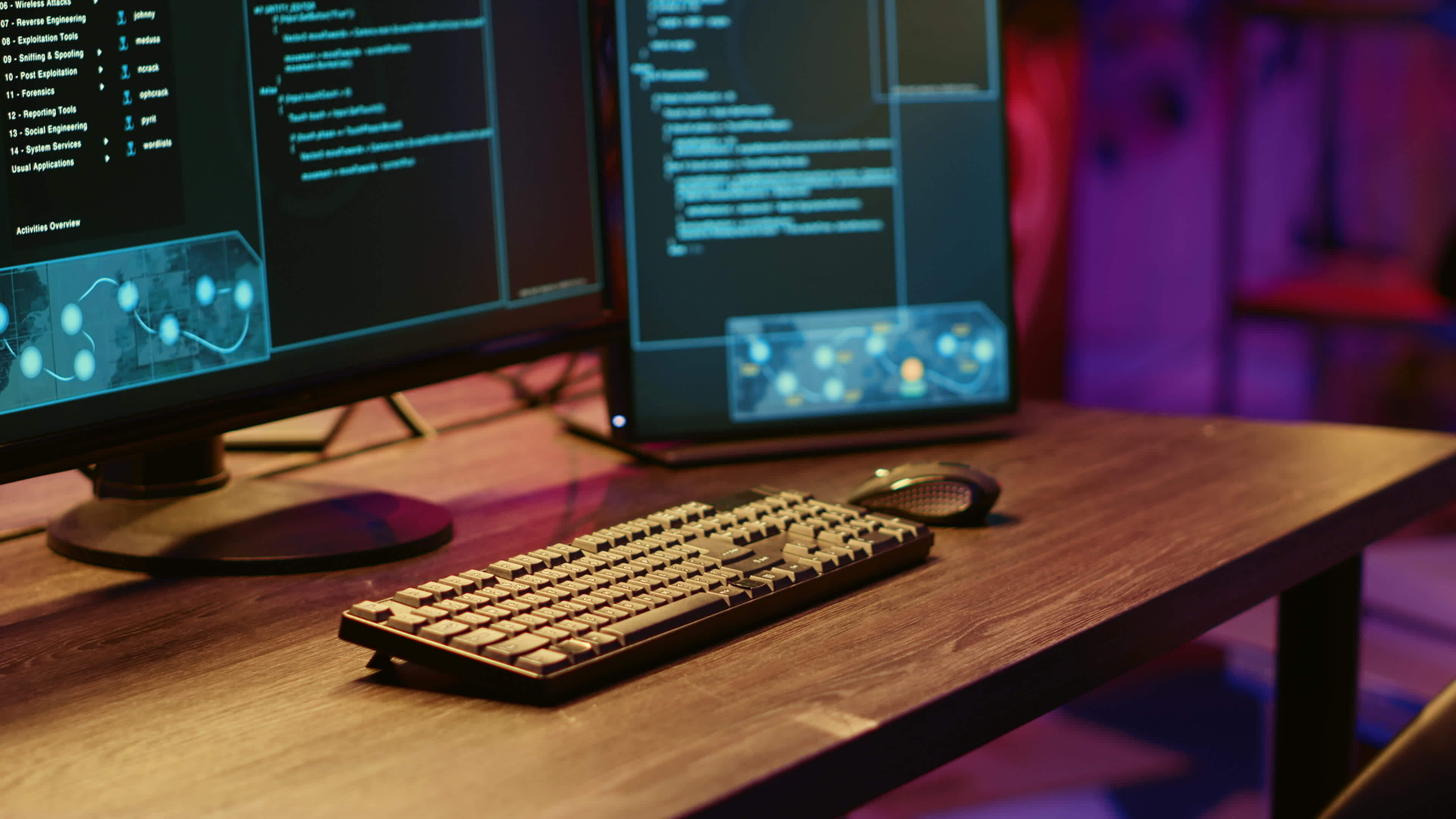 Close up shot of software interface on computer screens showing malicious hacking developer code ...