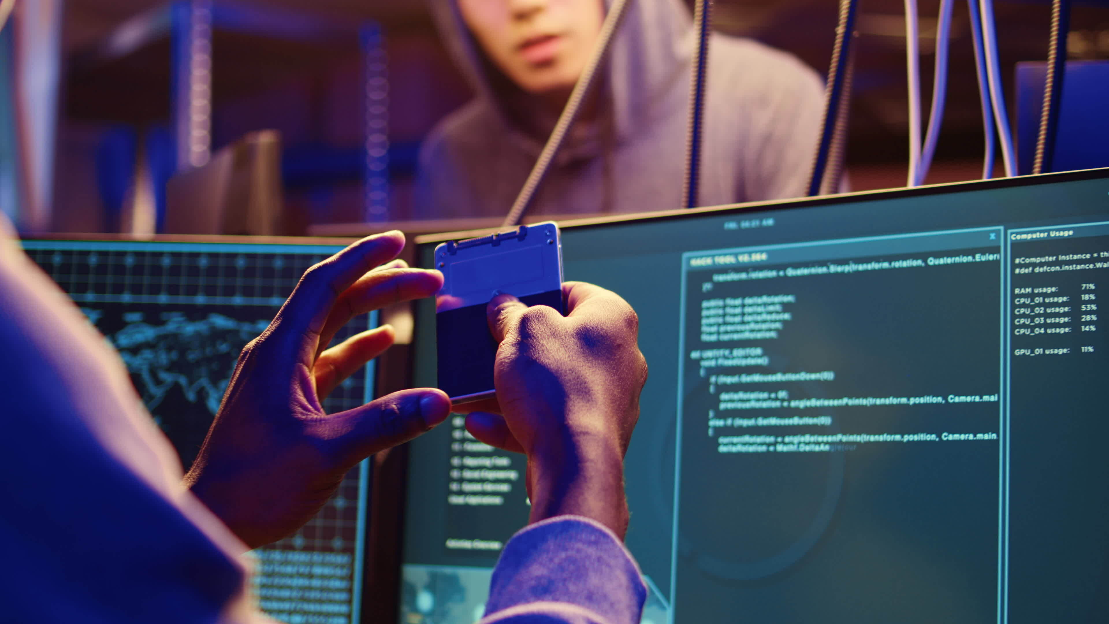 Close Up Shot On Hacker Holding Ssd Device With Zero Day Exploit