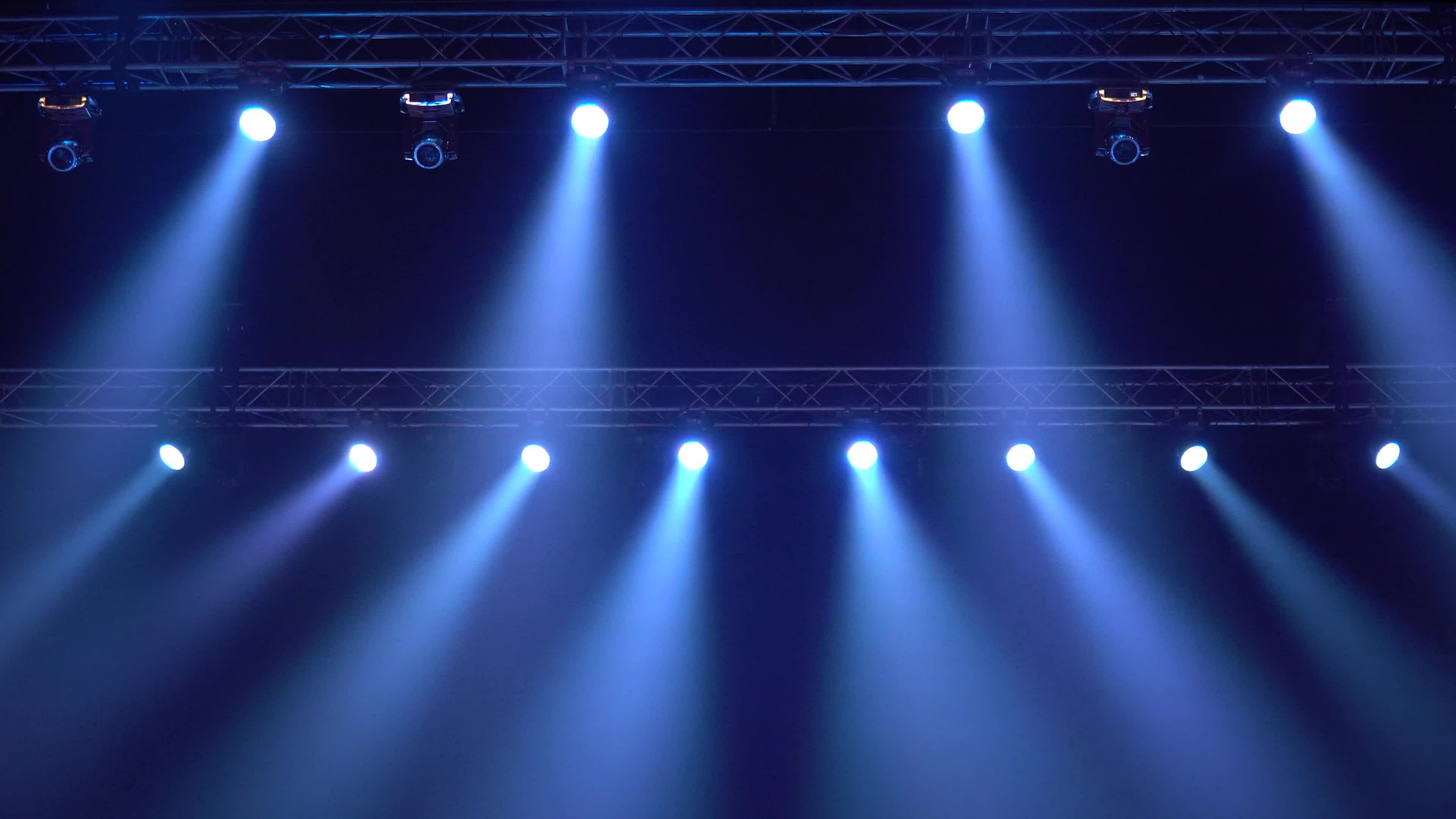 strobe blue light from stage lighting equipment in a concert hall ...