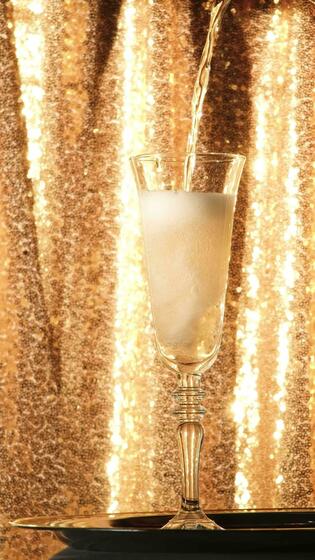 Champagne pouring into a glass on sparkling gold background 36018270 Stock Video at Vecteezy
