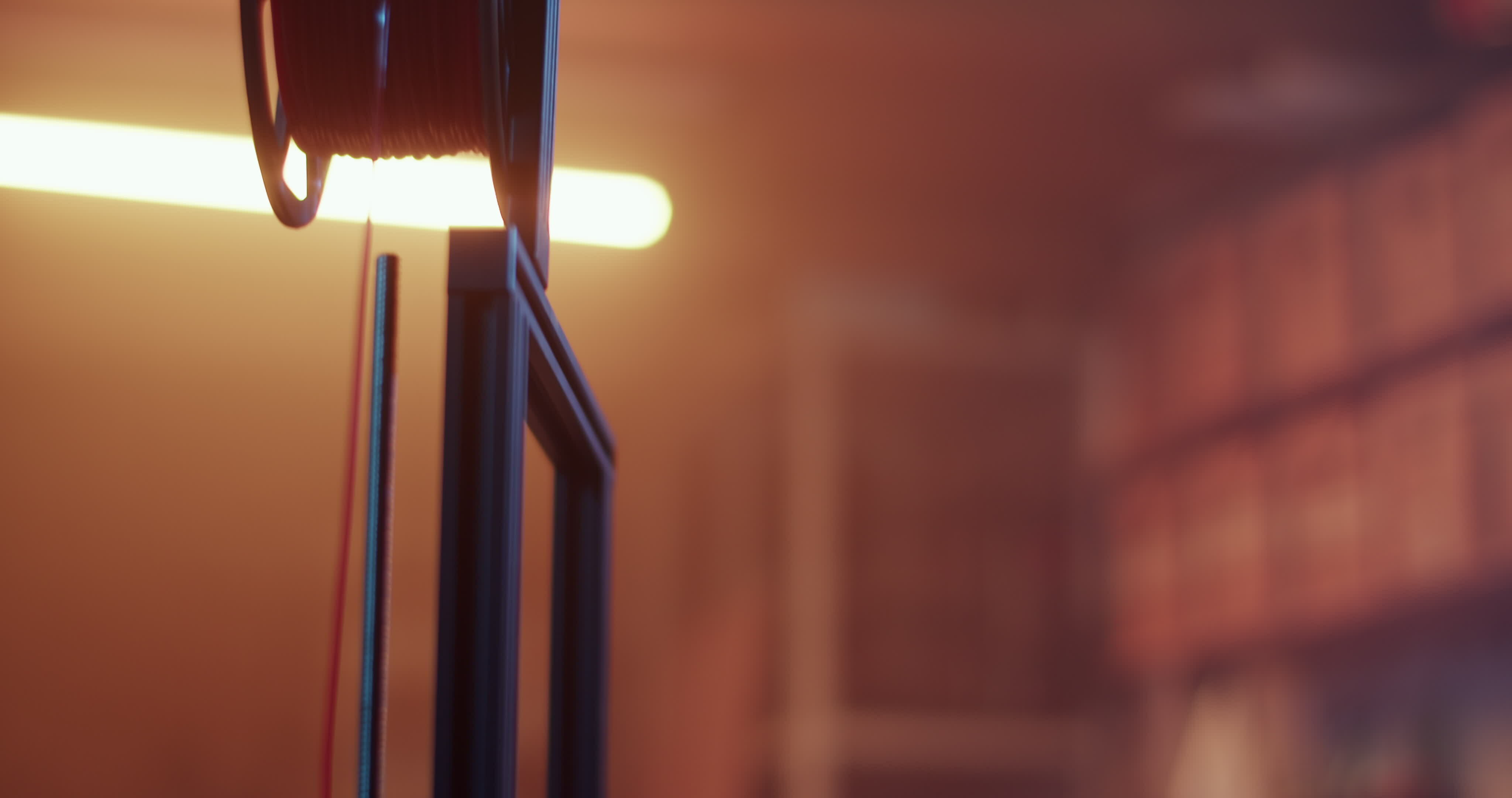 Male engineer using computer while creating 3D model with printer ...