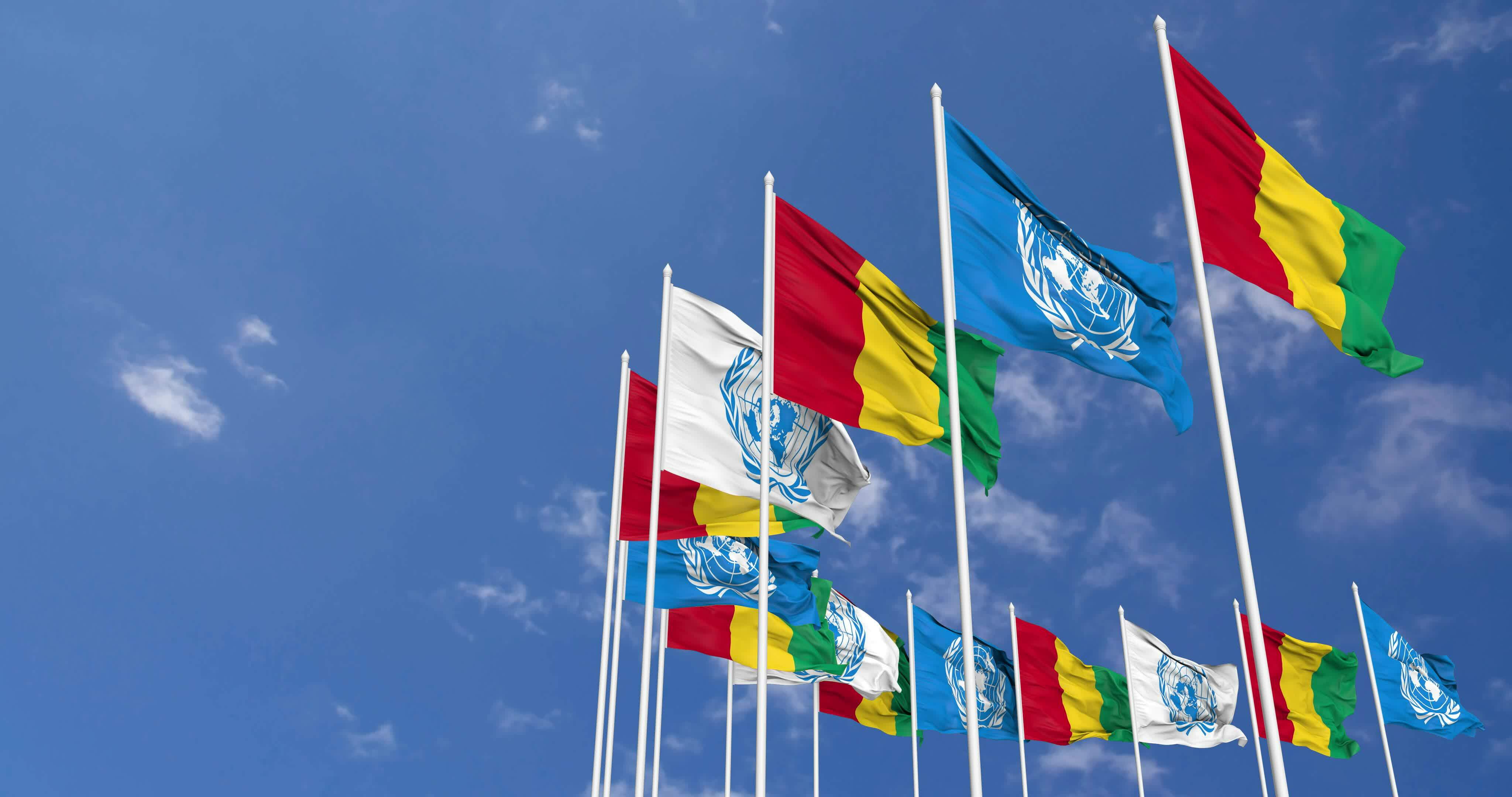 Guinea and United Nations, UN Flags Waving Together in the Sky, Seamless Loop in Wind, Space on ...