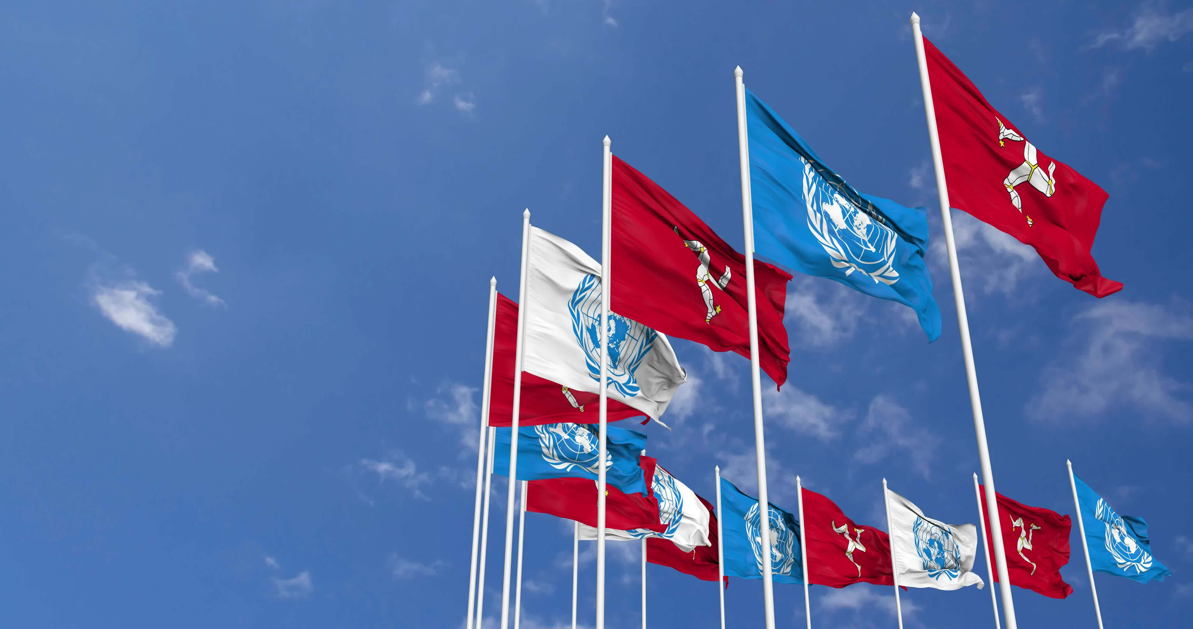 Isle of Man and United Nations, UN Flags Waving Together in the Sky, Seamless Loop in Wind ...