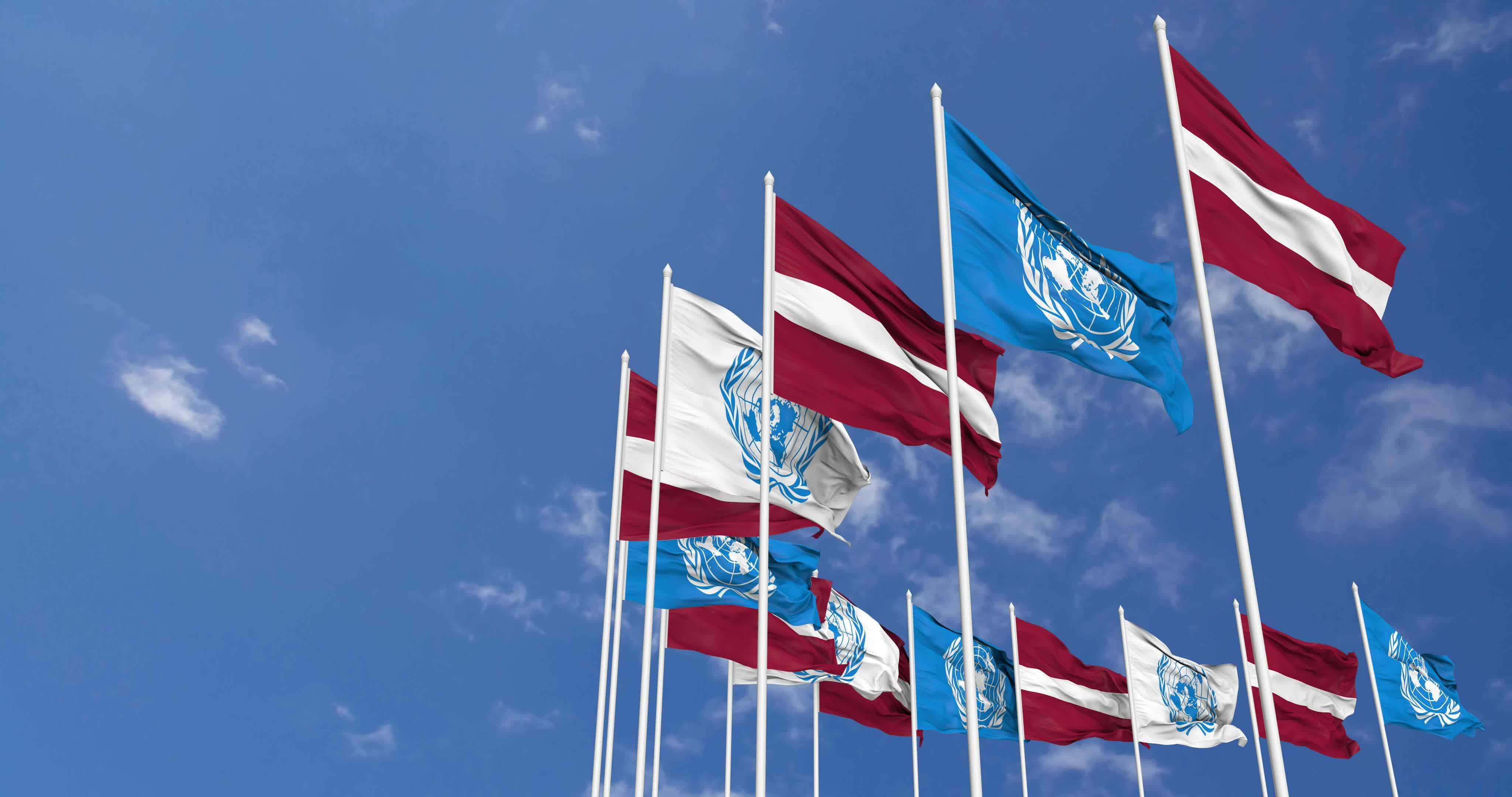 Latvia and United Nations, UN Flags Waving Together in the Sky, Seamless Loop in Wind, Space on ...