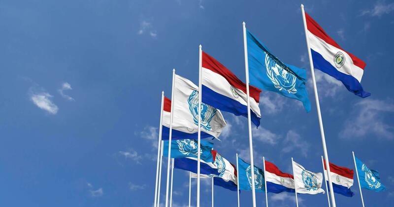Paraguay and United Nations, UN Flags Waving Together in the Sky, Seamless Loop in Wind, Space ...