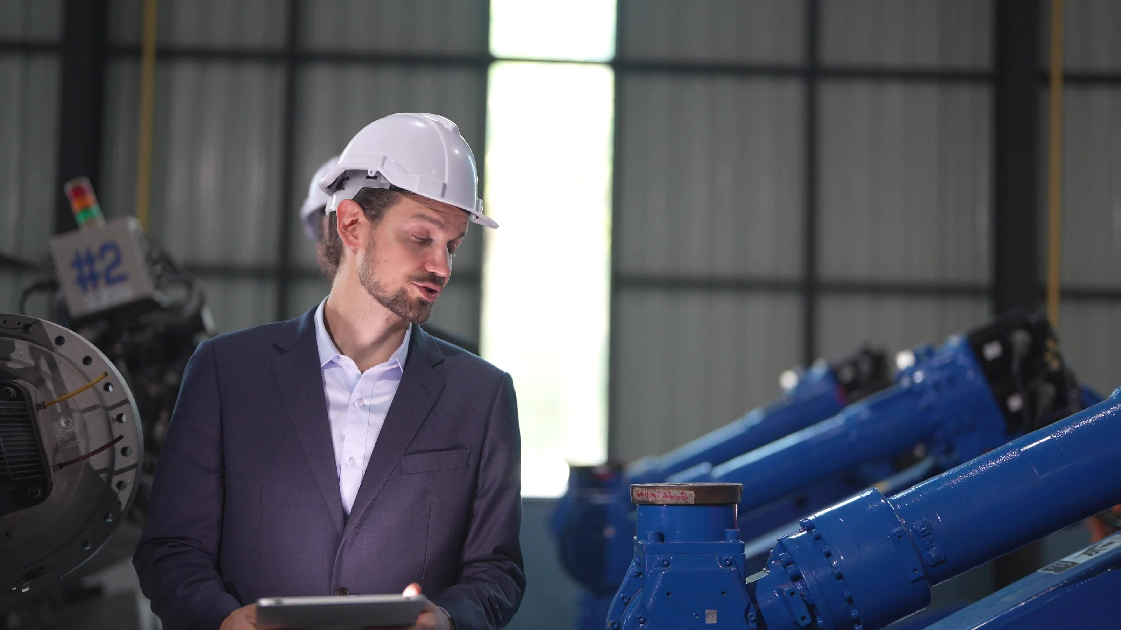 Business engineers meet and check control heavy machine robot arm ...