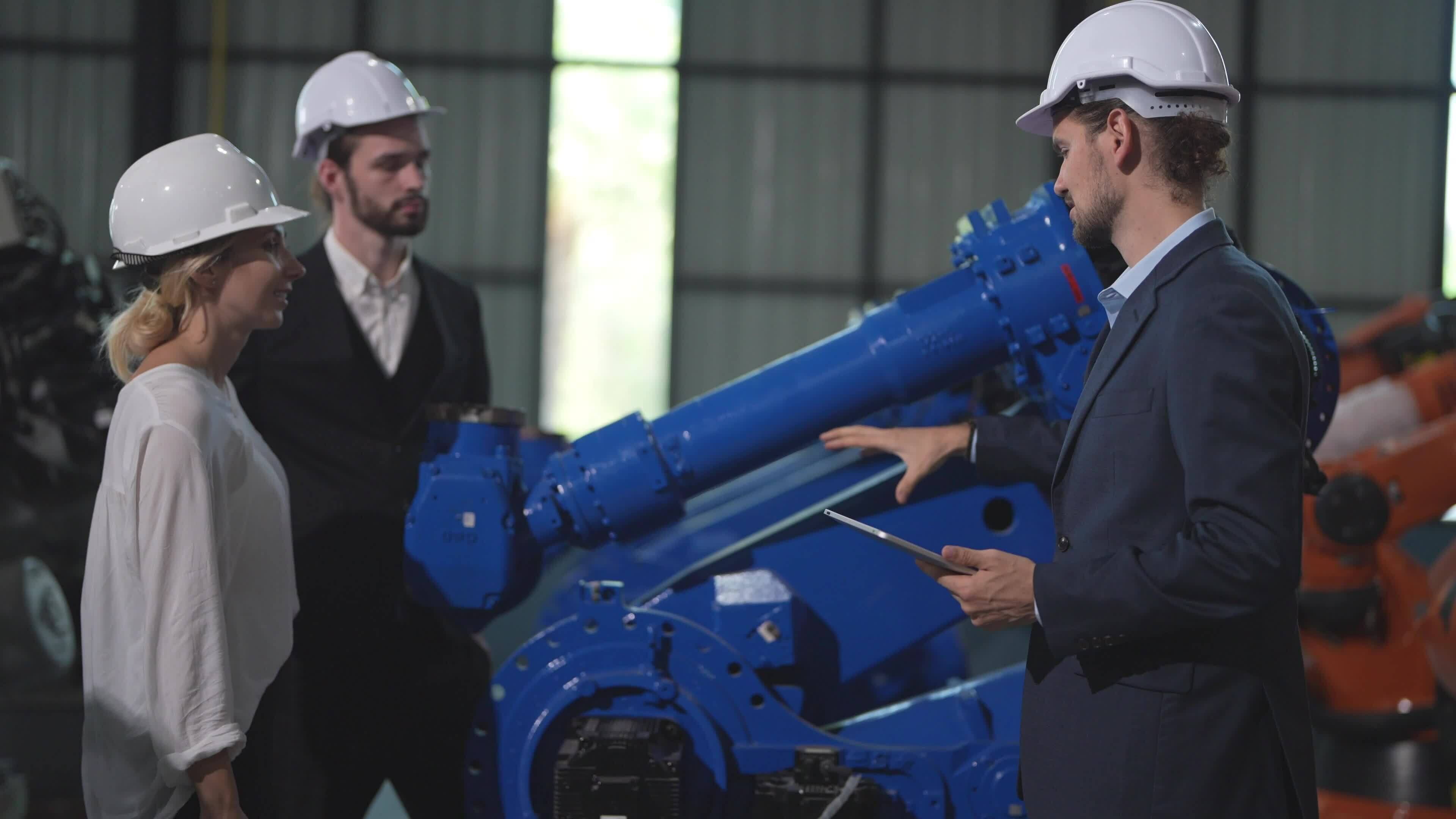 Business engineers meet and check control heavy machine robot arm ...