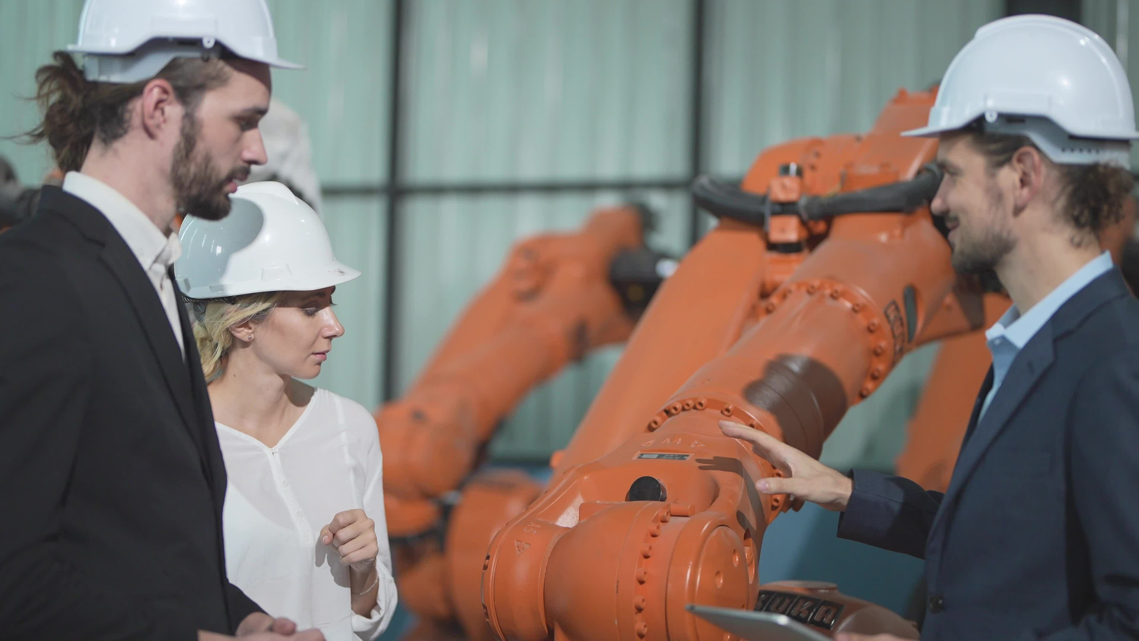 Business engineers meet and check control heavy machine robot arm ...