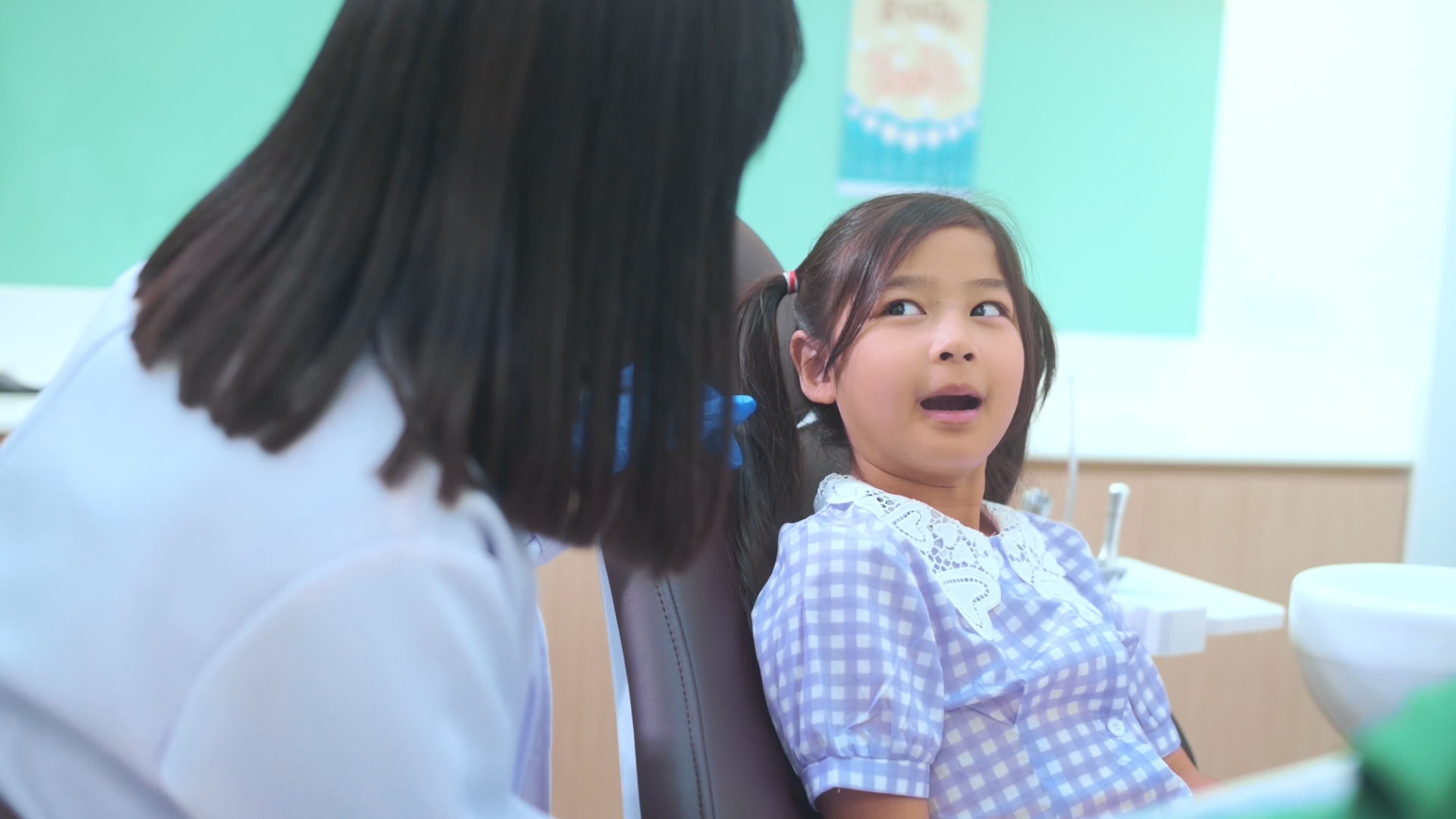 A little cute girl having teeth examined by dentist in dental clinic, teeth check-up and Healthy ...