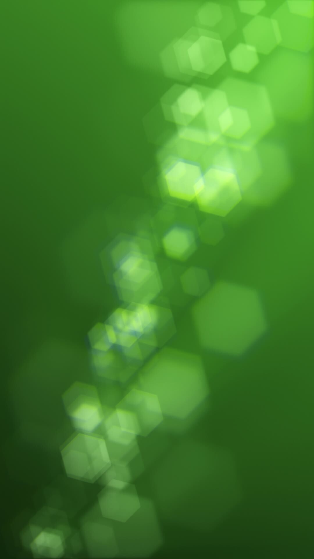 Vertical video - defocused green bokeh lights background. This motion animation with hexagonal ...