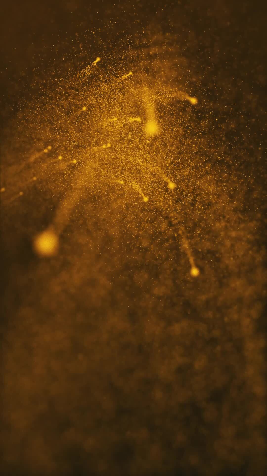 Vertical video - abstract background with glowing fiery golden energy particles flowing like ...