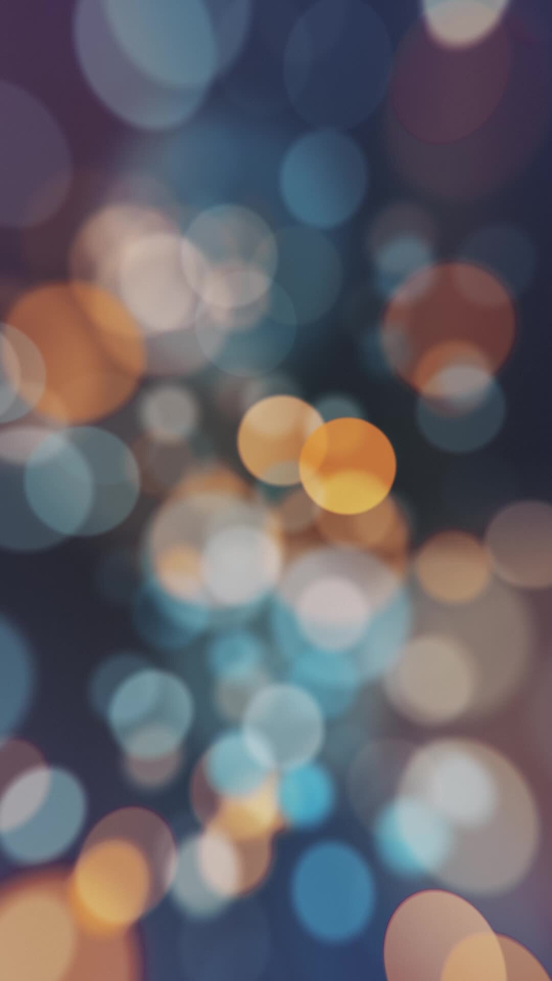 Vertical video - abstract bokeh background animation with gently flickering defocused warm blue ...