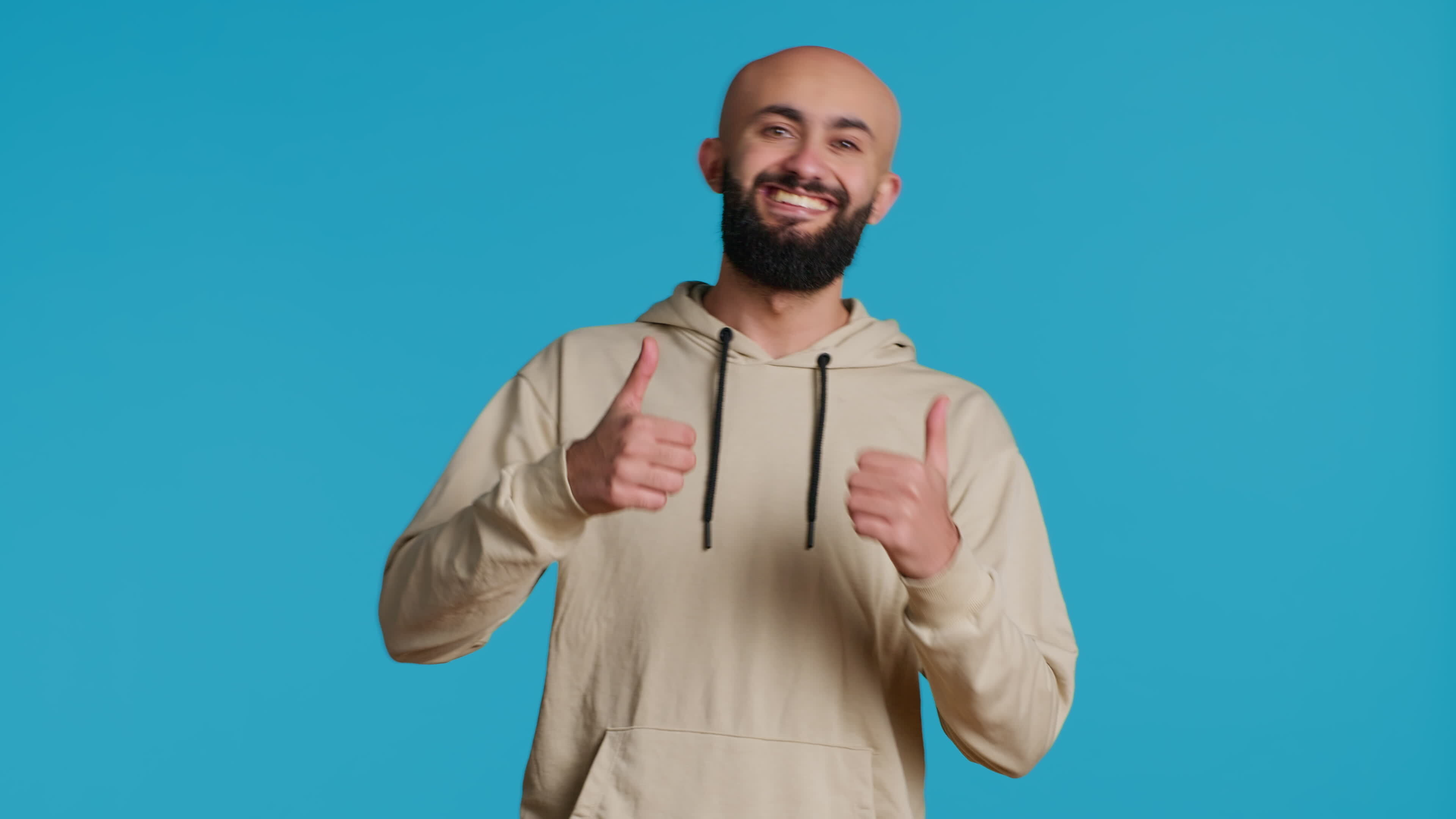 Middle eastern person giving thumbs up on camera, feeling cheerful and ... Middle eastern person giving thumbs up on camera, feeling cheerful and ...