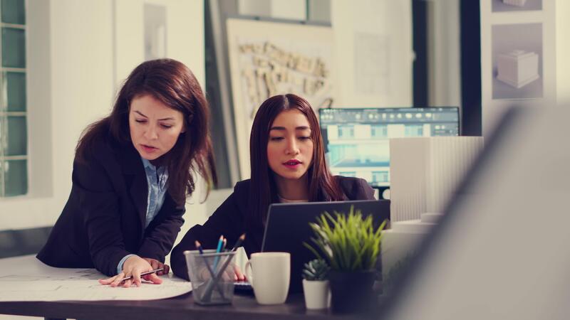 Industrial engineers designing floor plan sketch on cad software, using ...