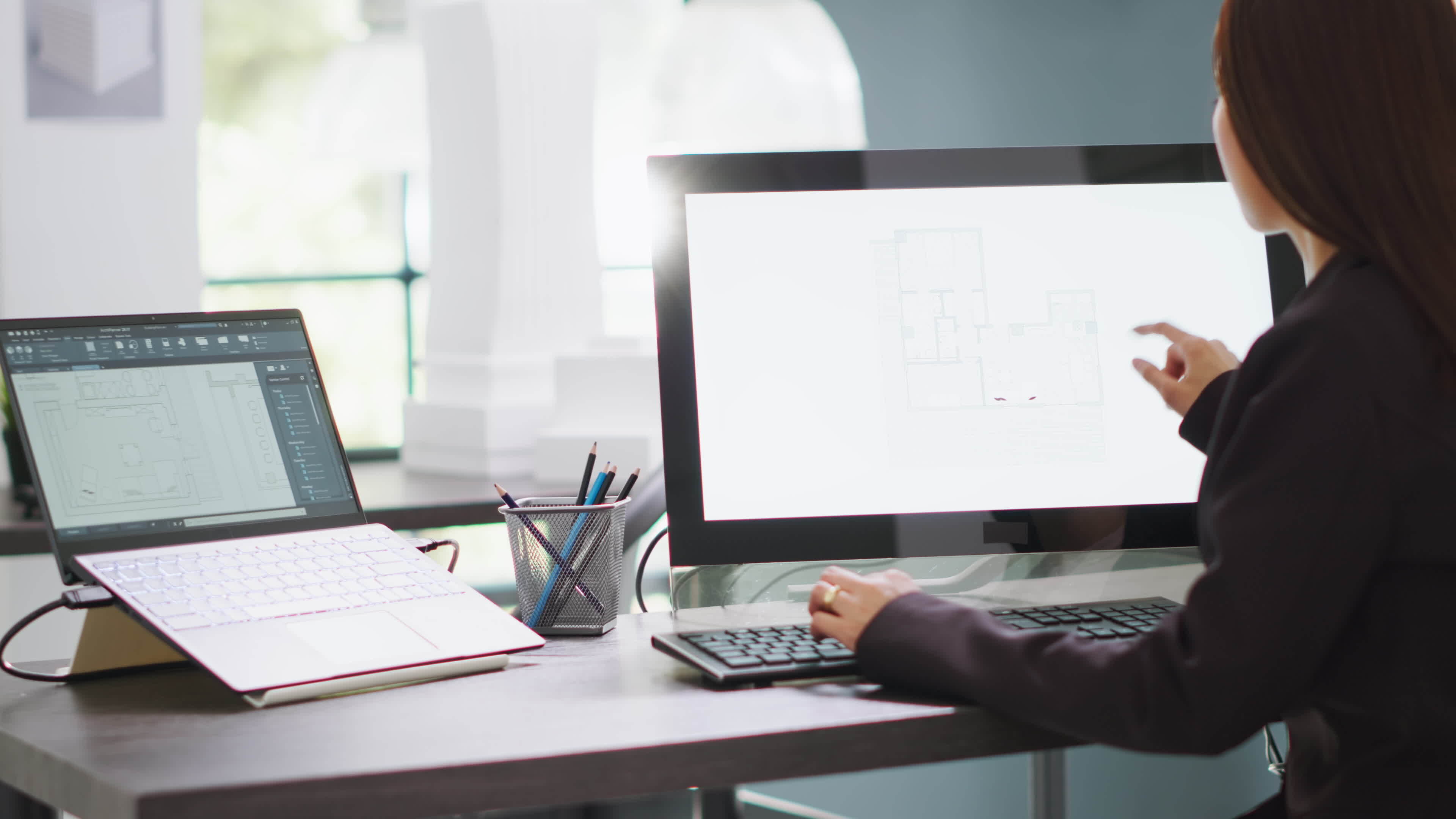 Architect designing blueprints for house remodeling project, using ...