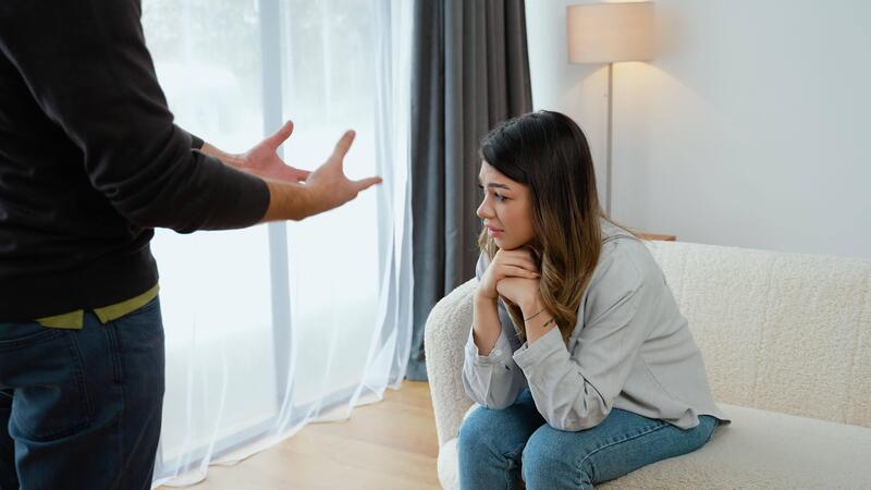 Upset wife sit on couch crying listening to furious husband yelling ...