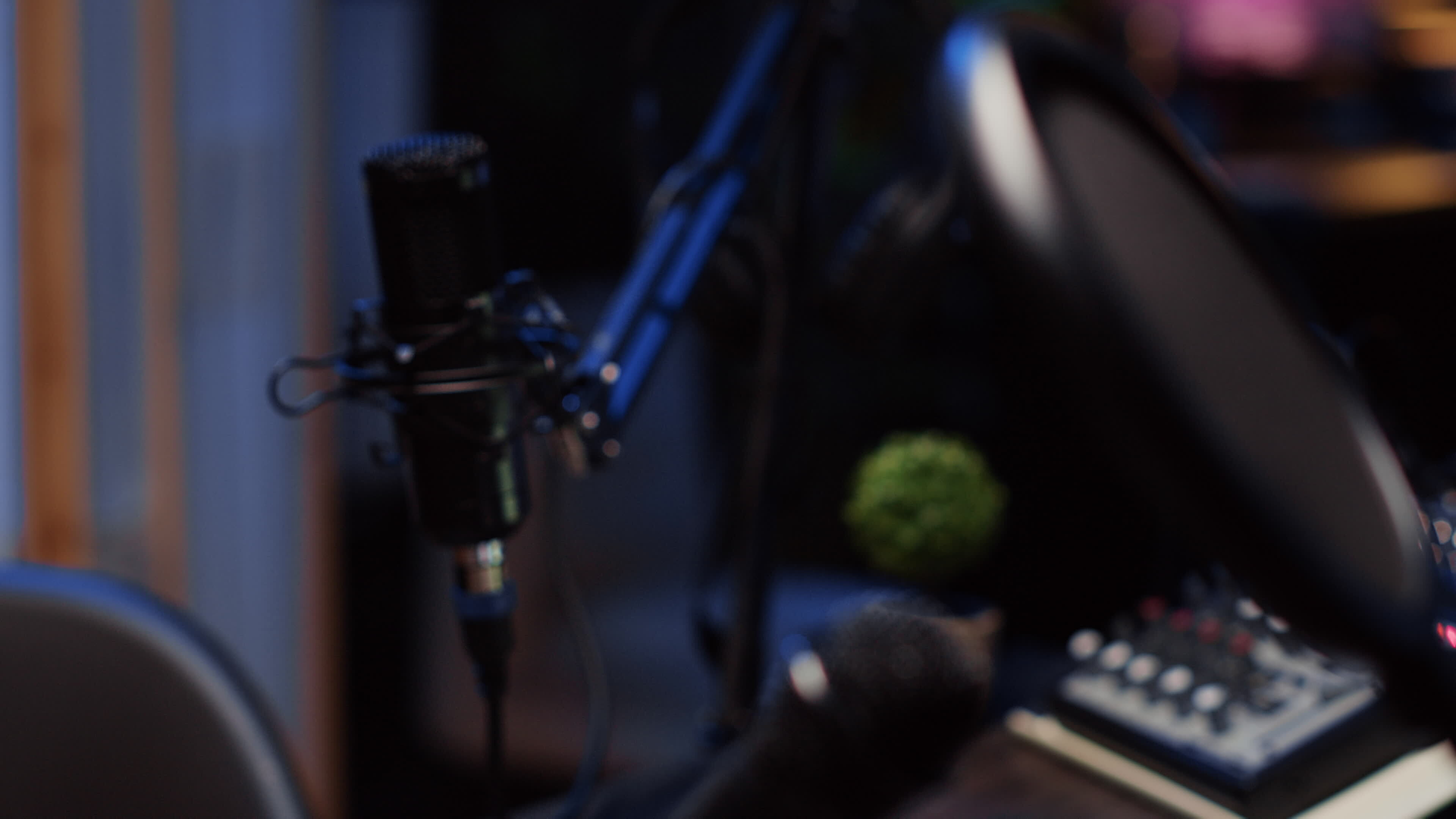 Zoom out shot of podcast microphone used to record conversations with impeccable sound quality ...