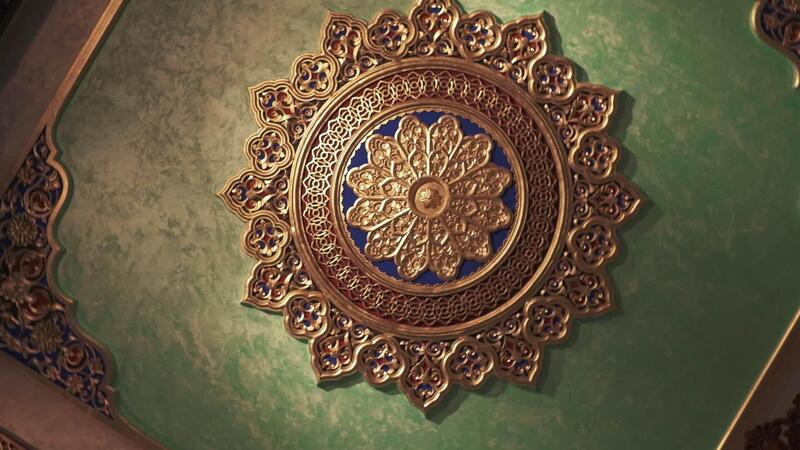 Dining room with richly colored walls and ceiling with Arabic-oriental ...