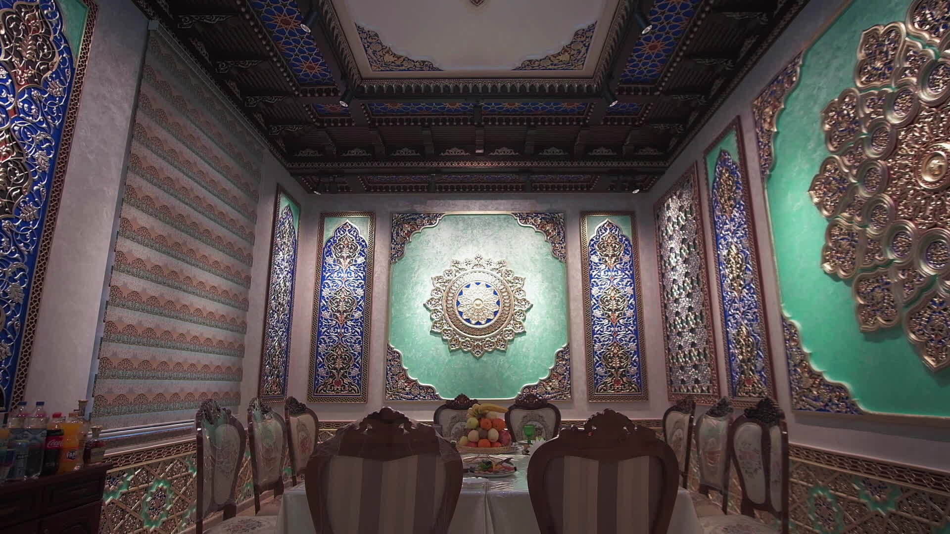 Dining room with richly colored walls and ceiling with Arabic-oriental ...