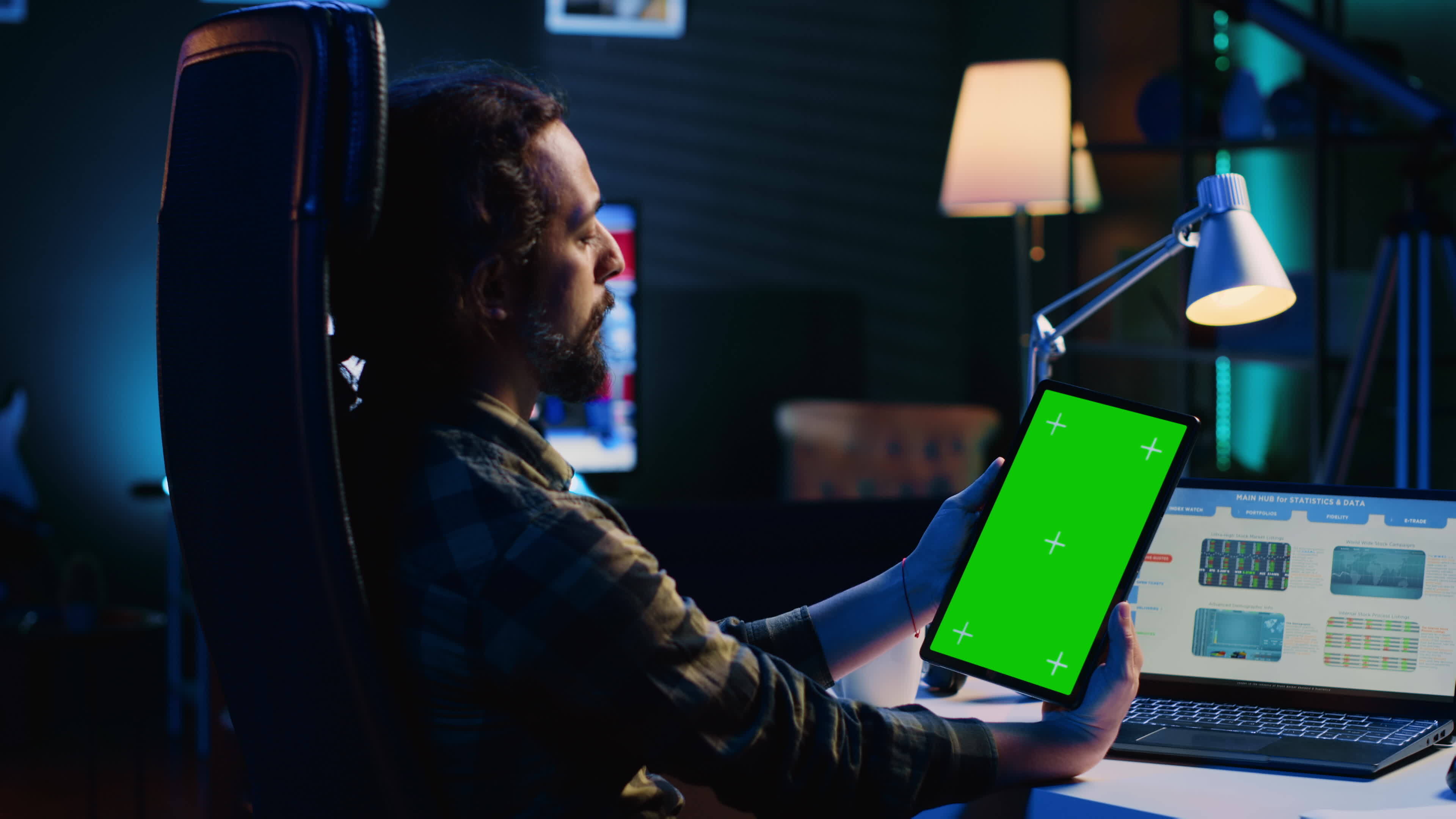 Remotely Working Man In Home Office Checks Statistical Financial Graphs On Laptop Crosschecking