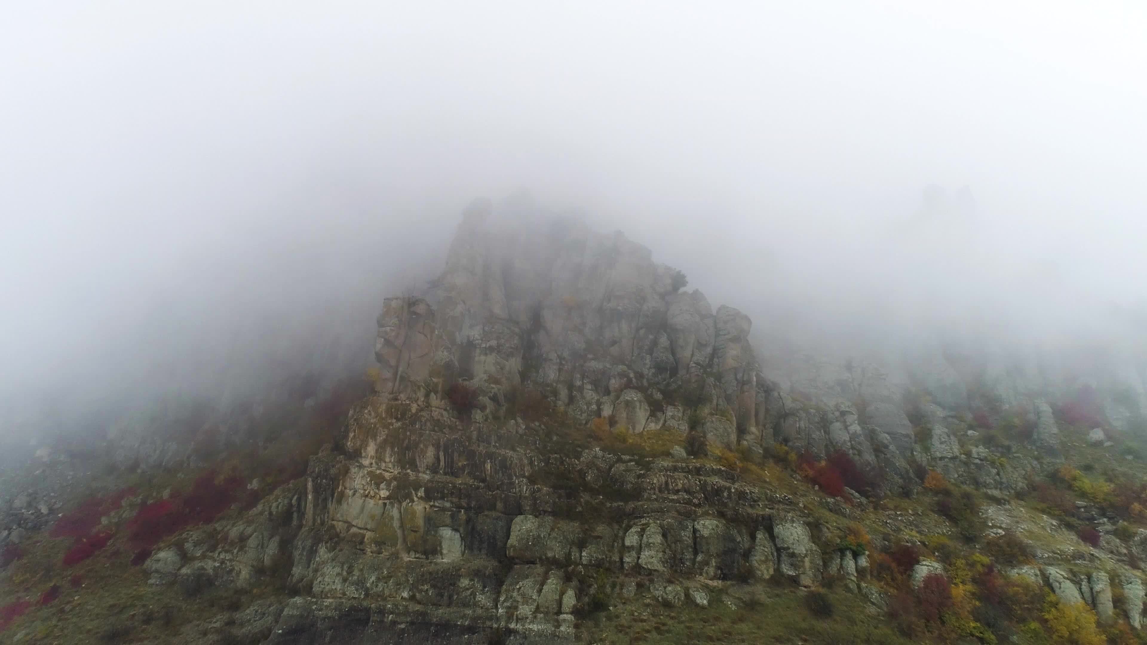 Aerial view on rocky mountains in the fog. Shot. Beautiful foggy ...