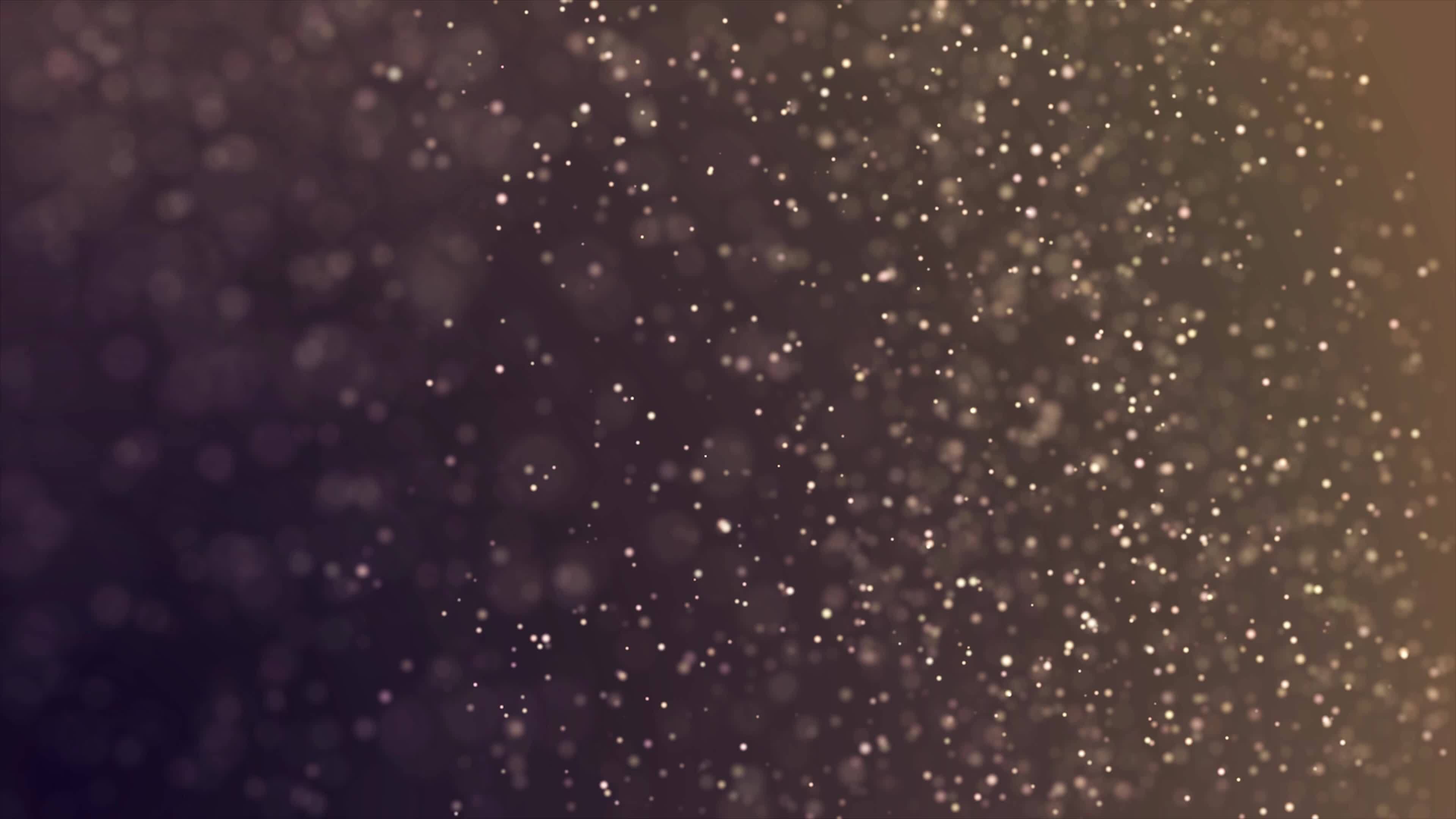 Glittering particles sparkle and drift along. Abstract background with shining bokeh sparkles ...