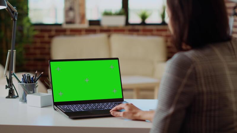 Freelancer Checking Emails On Green Screen Laptop During Work From Home At Computer Desk Self