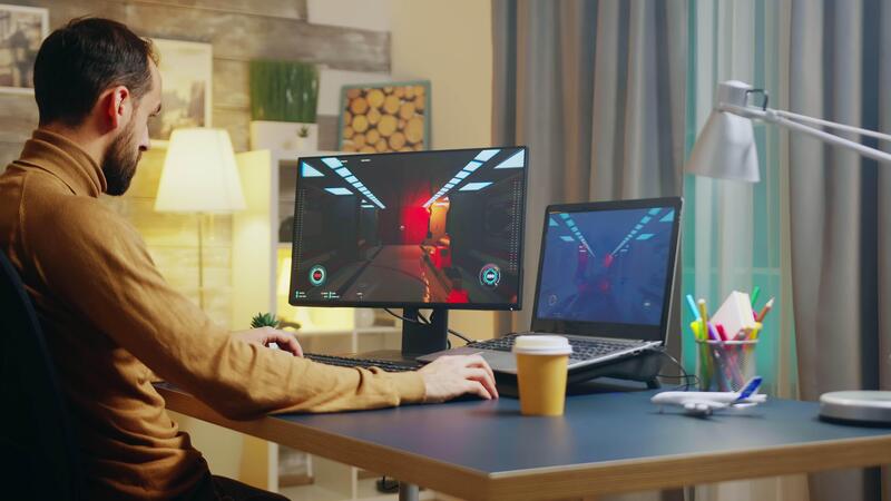 Young game creator testing the interface of shooter game. Game ...