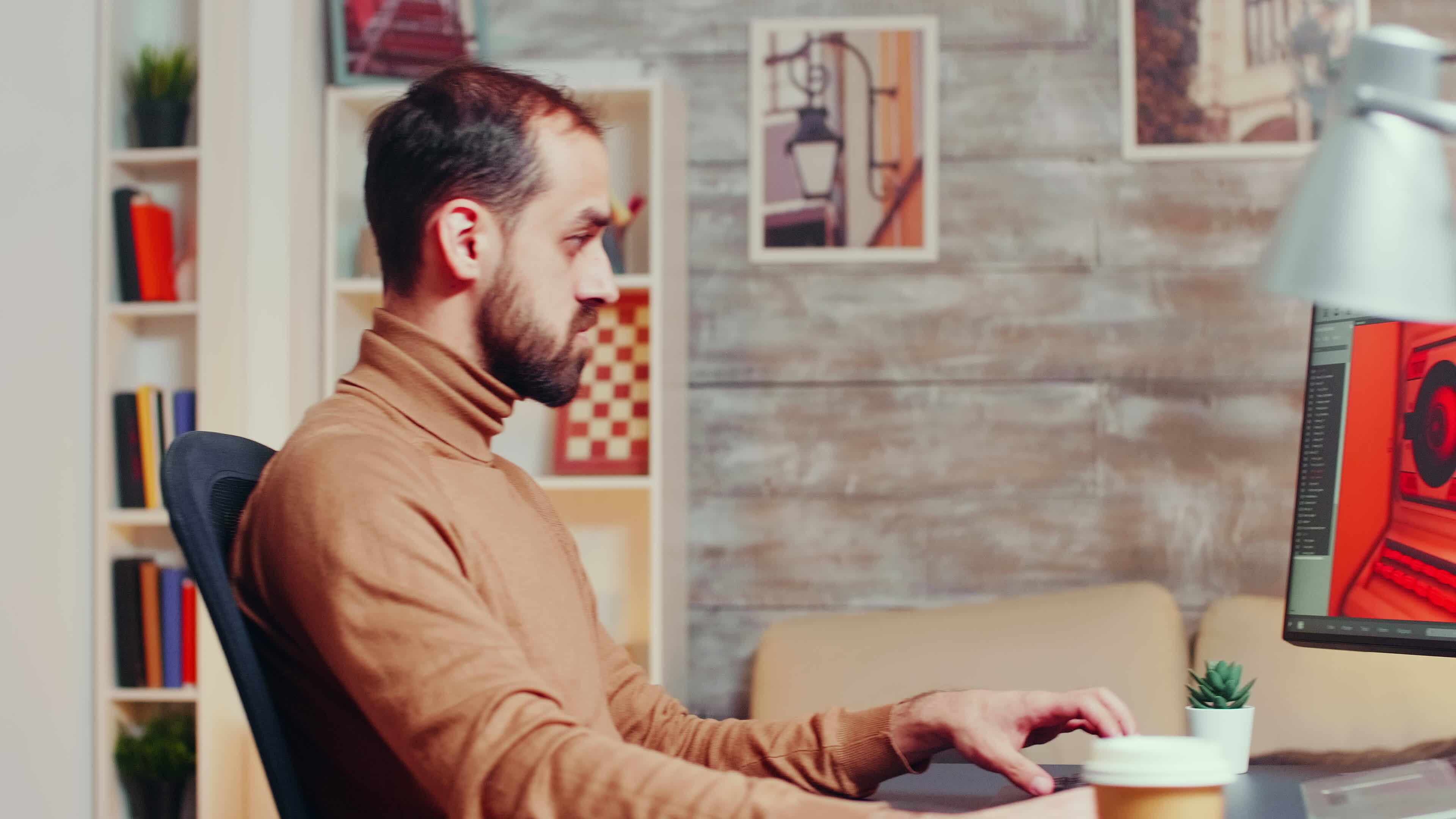 Young game developer using modern software to design the interface ...