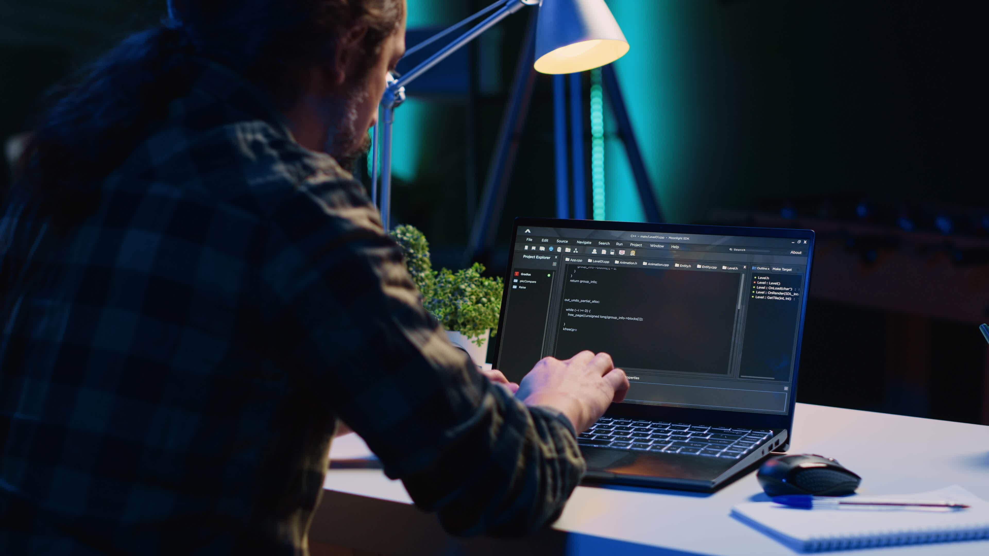 Skilled computer scientist writes code on laptop screen while in living ...