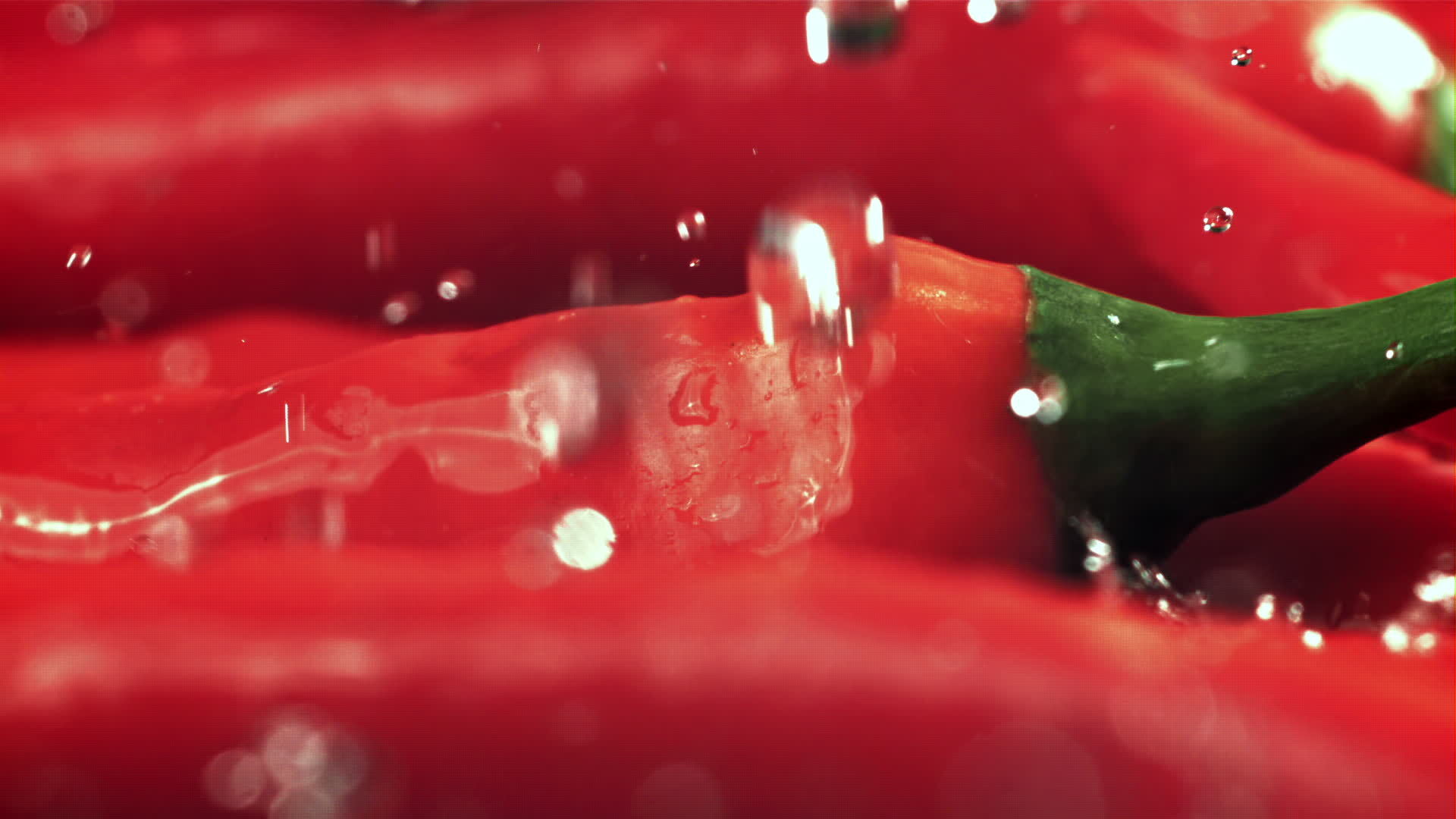 Drops of water fall on chili peppers. Filmed on a high-speed camera at 1000 fps. High quality ...