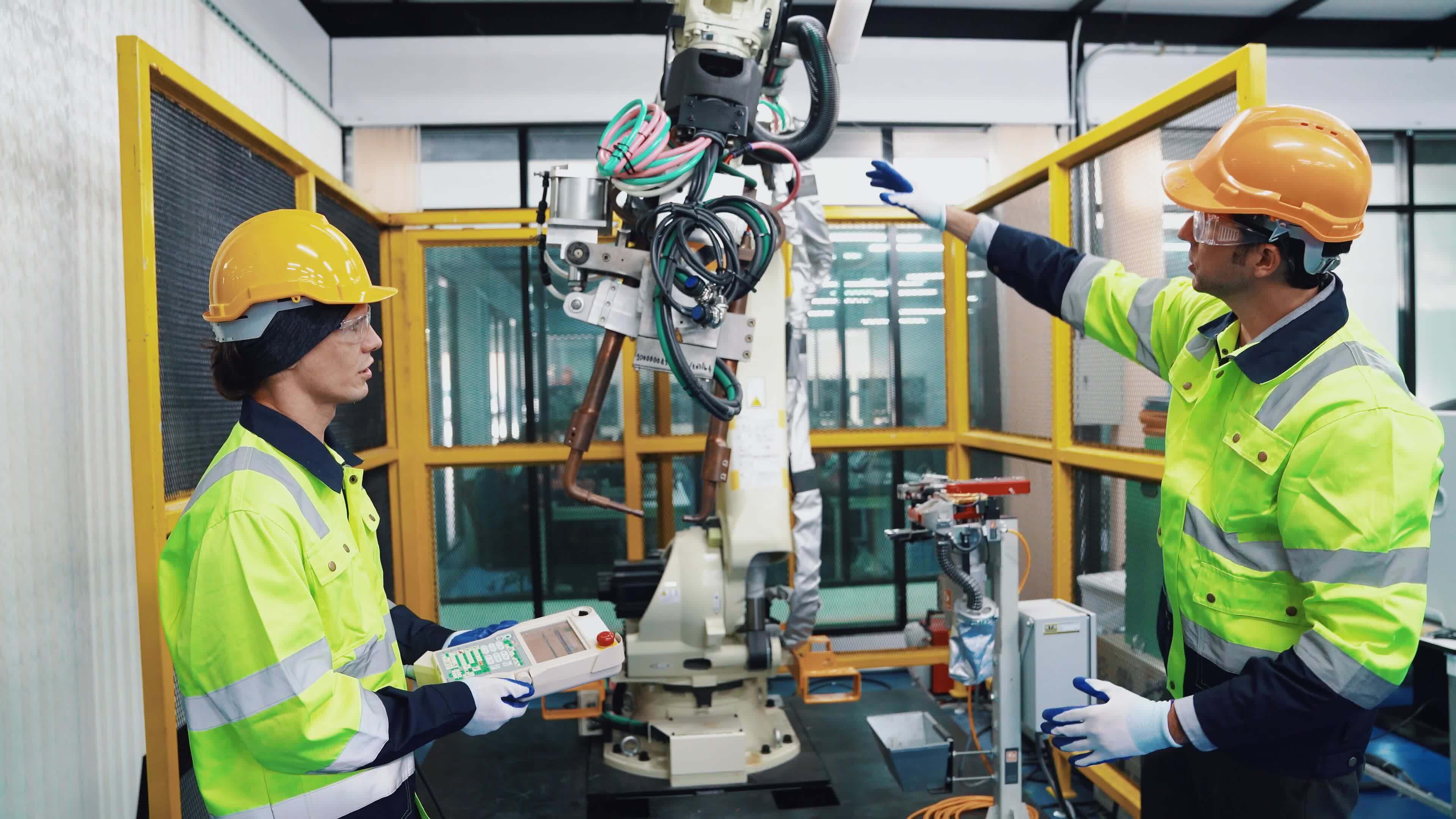 Engineer working and controlling robotics with monitoring system software automation robot arm ...