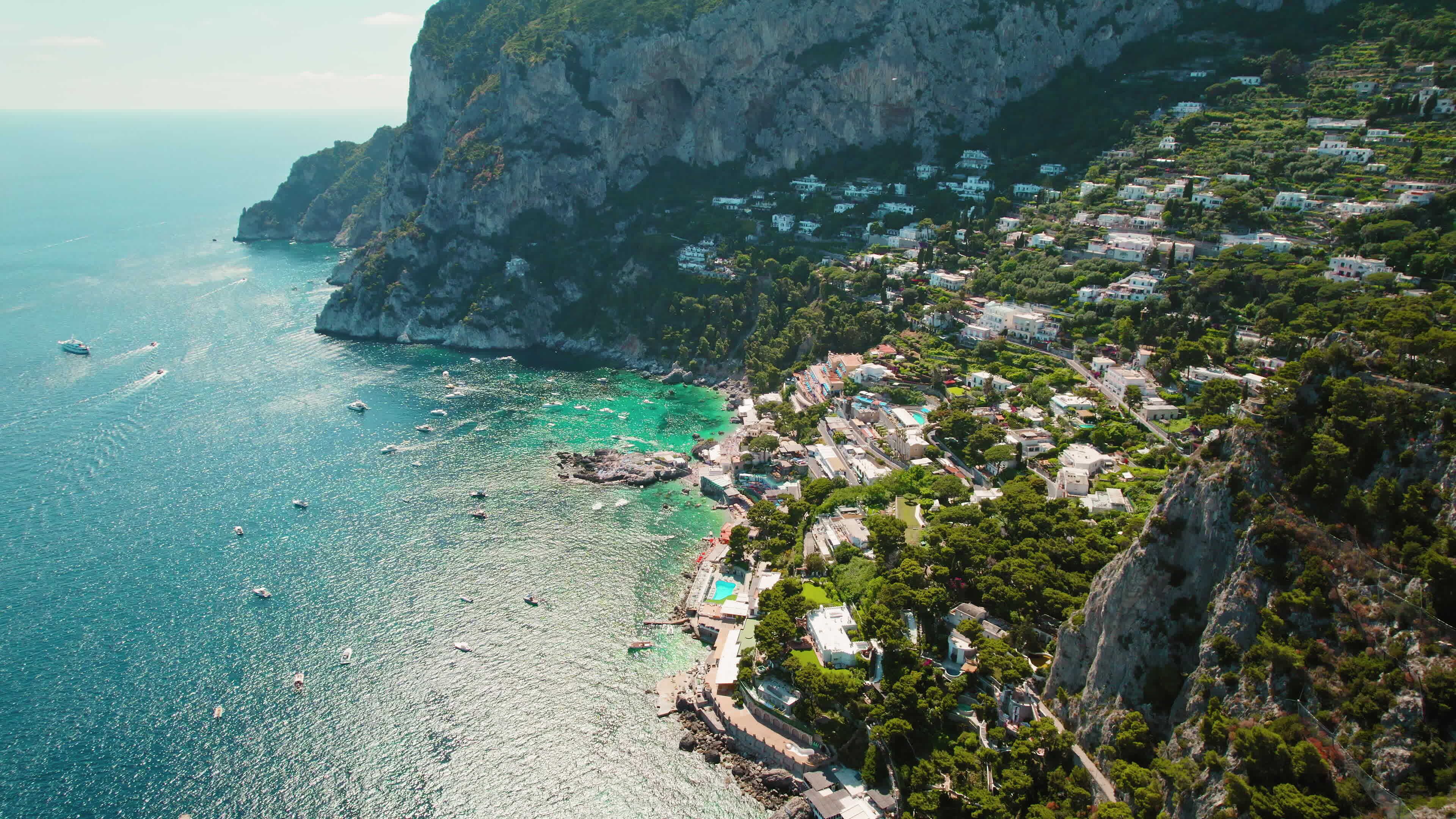 Aerial view of Capri Island with rugged coastline and azure Tyrrhenian Sea in summer Italy ...