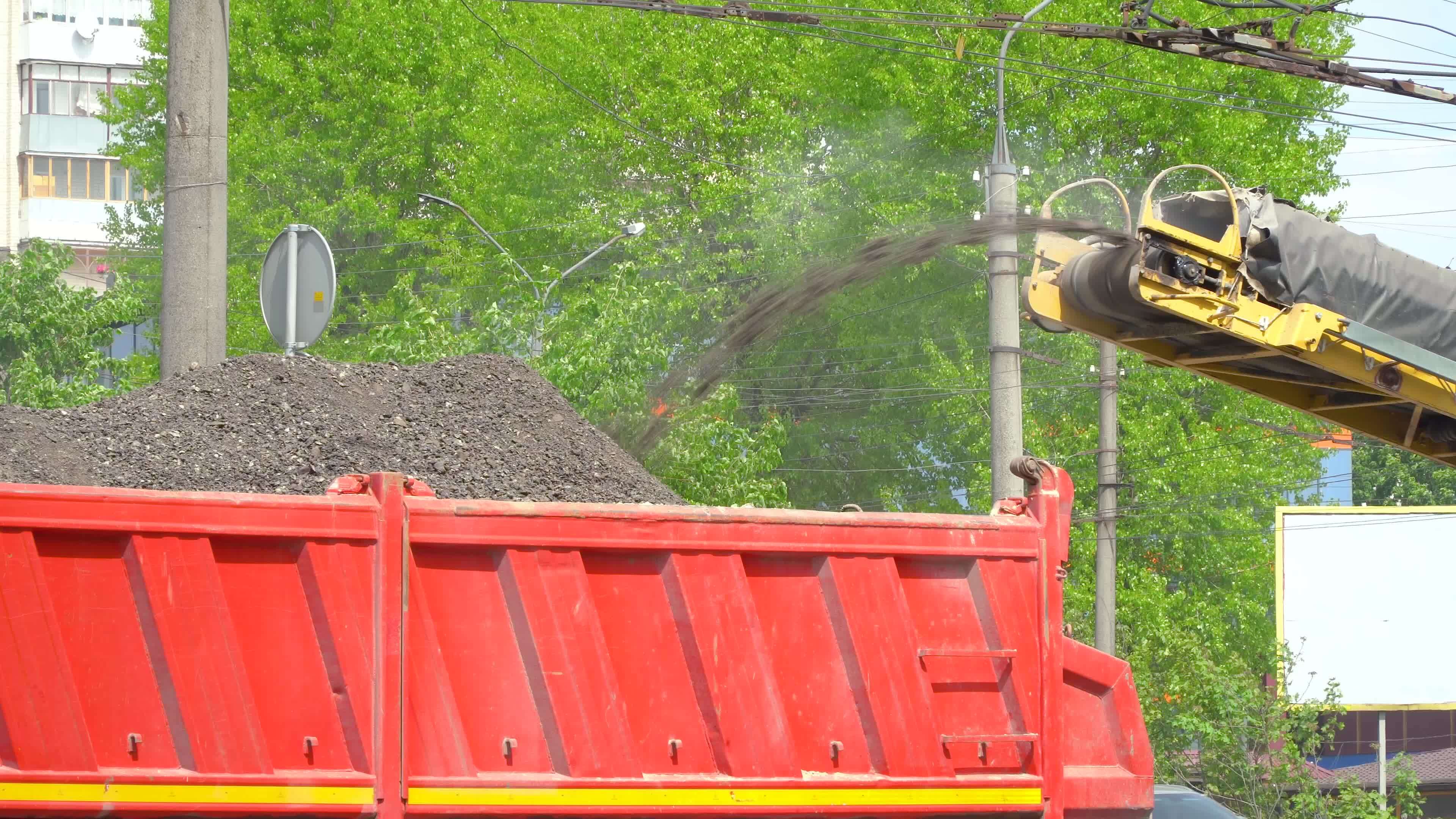 Dismantling of asphalt pavement. Workers cut off the old asphalt and ...